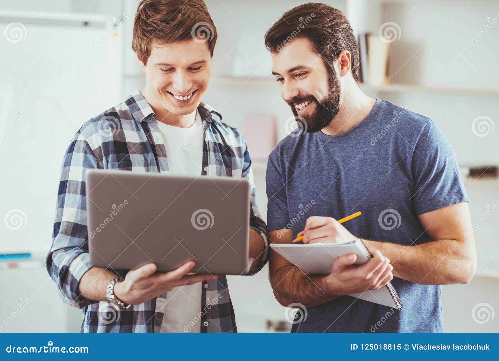 Positive Young Men Working Together Stock Image - Image of device ...