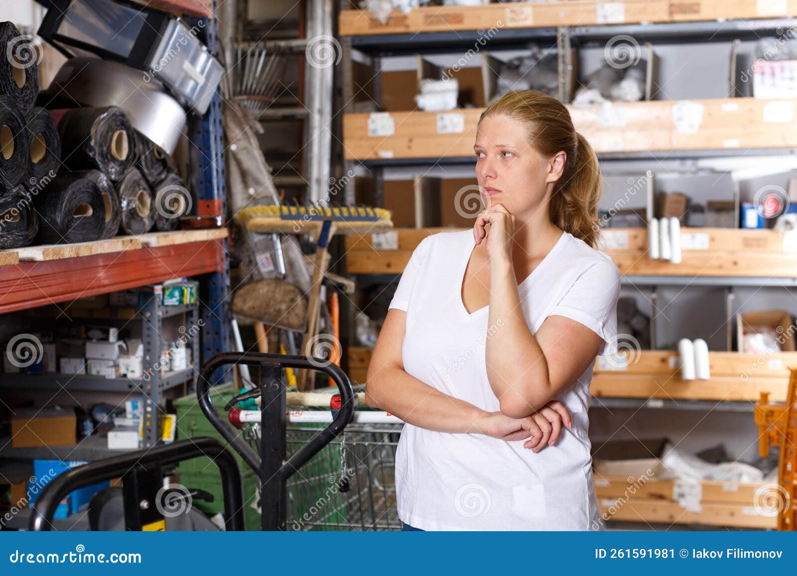 Positive Young Woman Looking Tools with Note List in Build Store Stock ...