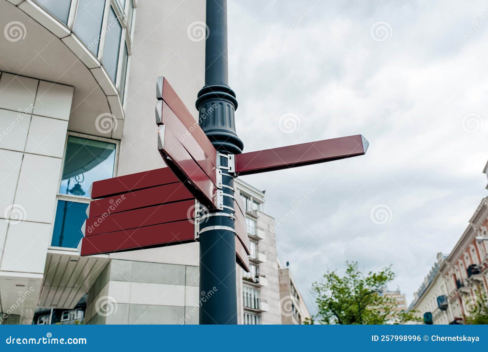 Post with Blank Direction Signs on City Street, Low Angle View Stock ...