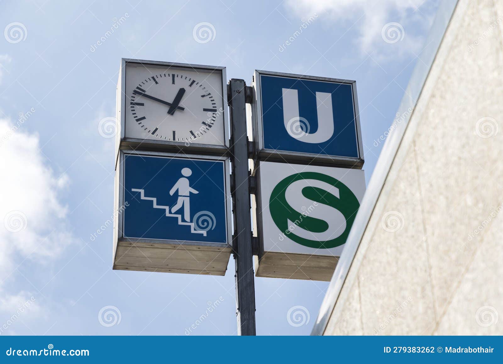 Post with a Clock and Signs for S-bahn and U-bahn in a German City ...