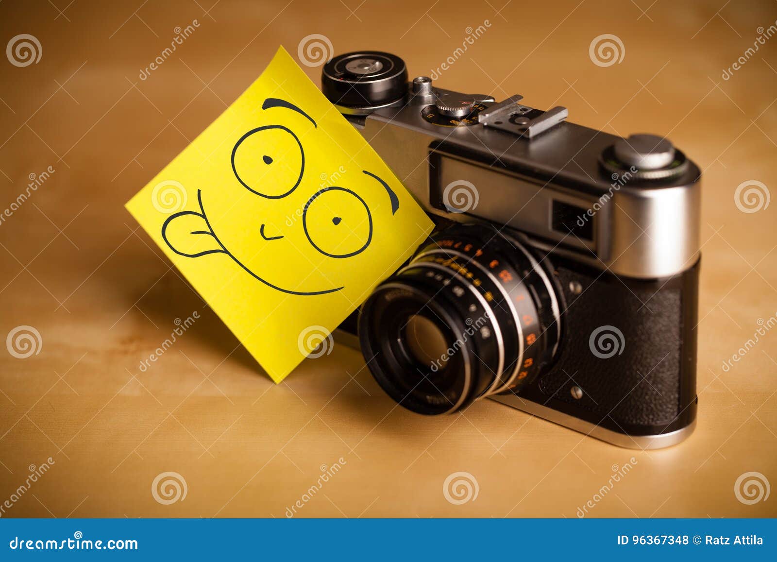 Post-it Note with Smiley Face Sticked on a Photo Camera Stock Photo ...
