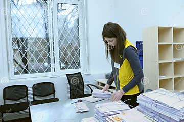At the Post Office, Sorting Room: Young Woman Postal Worker in Uniform ...