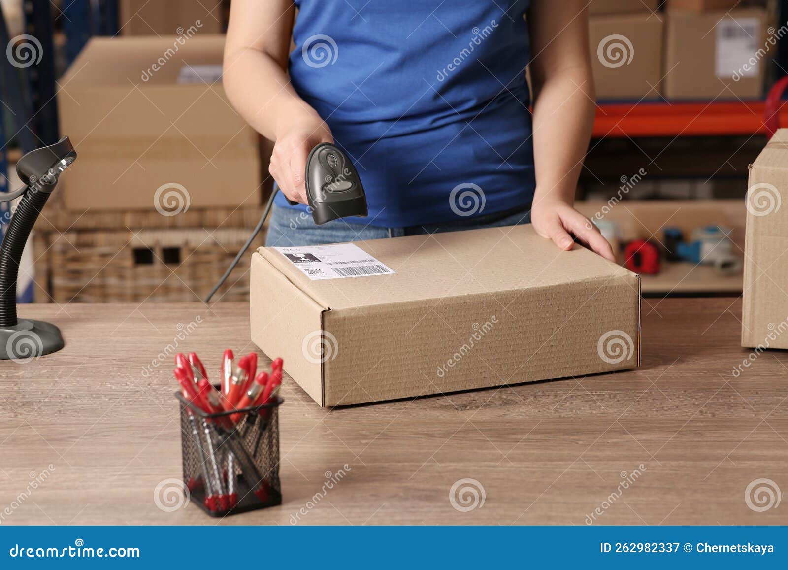 Post Office Worker with Scanner Reading Parcel Barcode at Counter ...