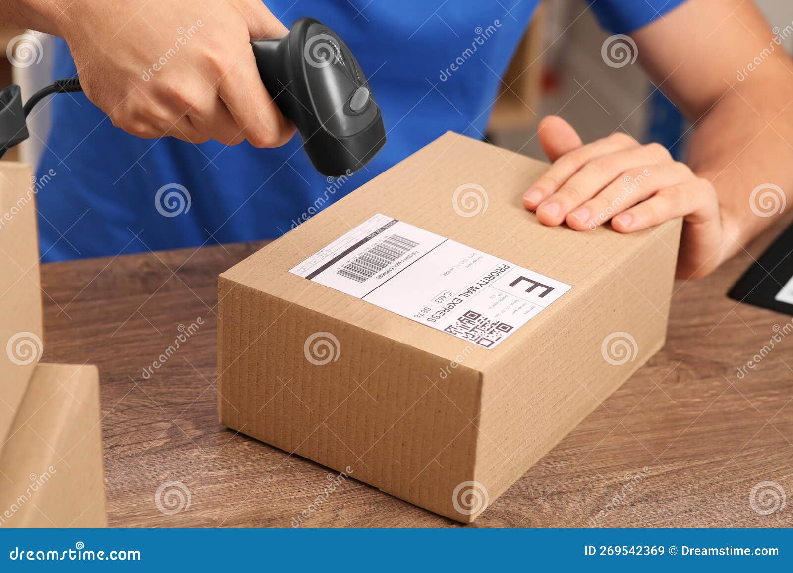 Post Office Worker with Scanner Reading Parcel Barcode at Counter ...