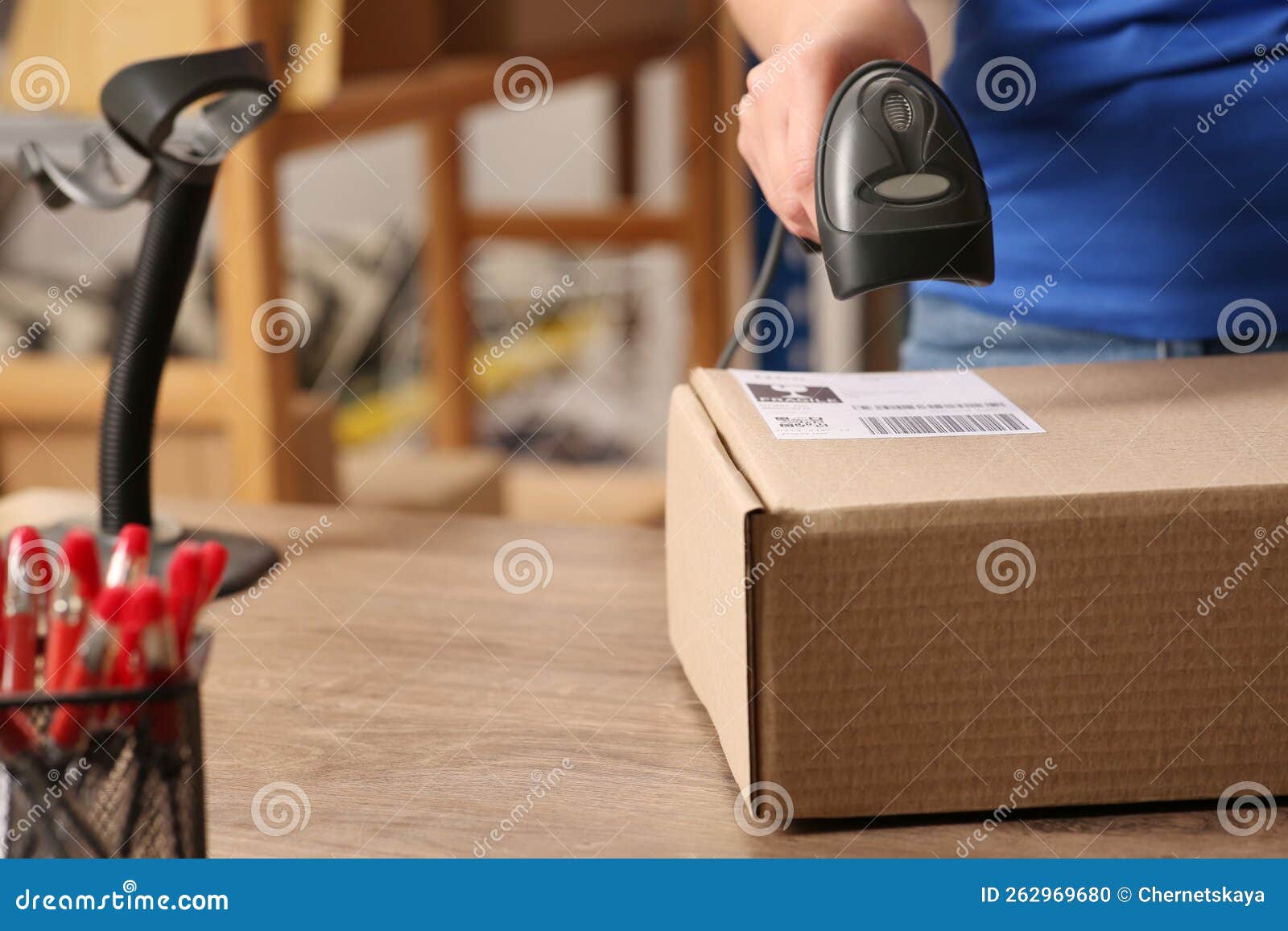 Post Office Worker with Scanner Reading Parcel Barcode at Counter ...