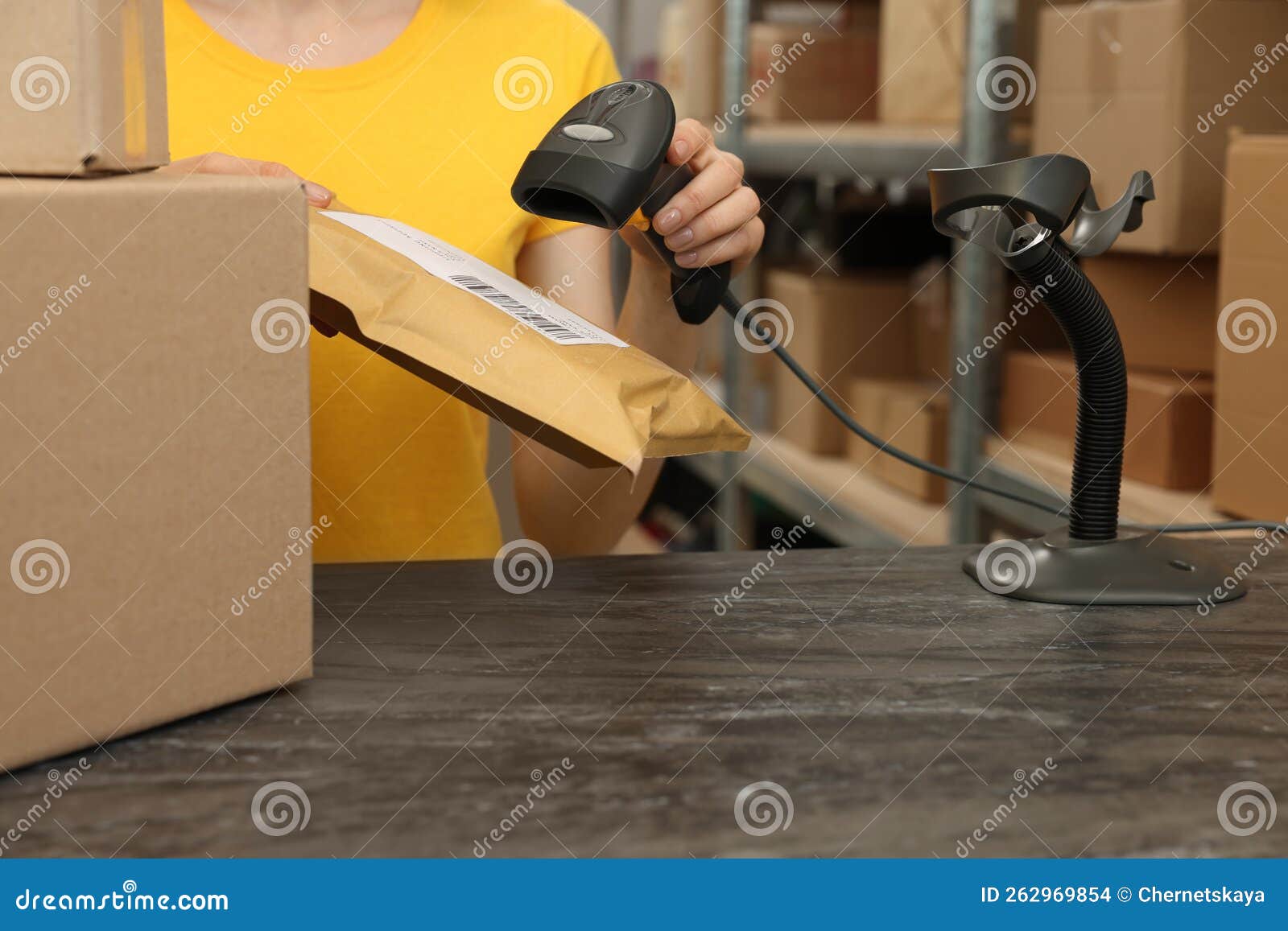 Post Office Worker with Scanner Reading Parcel Barcode at Counter ...