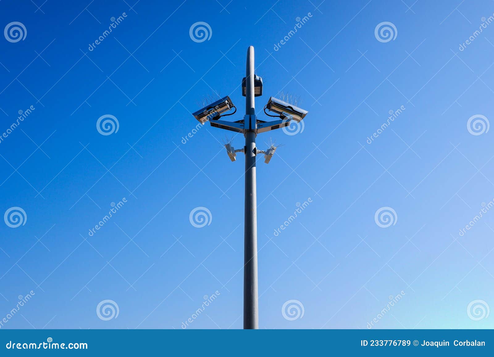 A Post with Several Security Cameras and Light Bulbs To Control ...