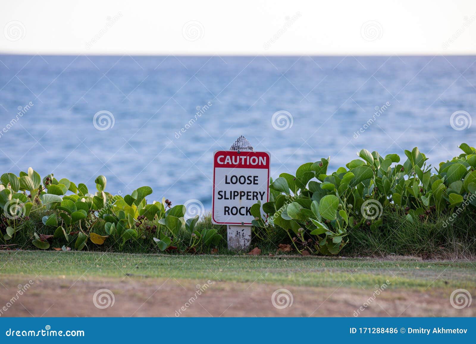 Posted Sign on an Edge of a Cliff Read `Caution` and ` Loose Slippery ...