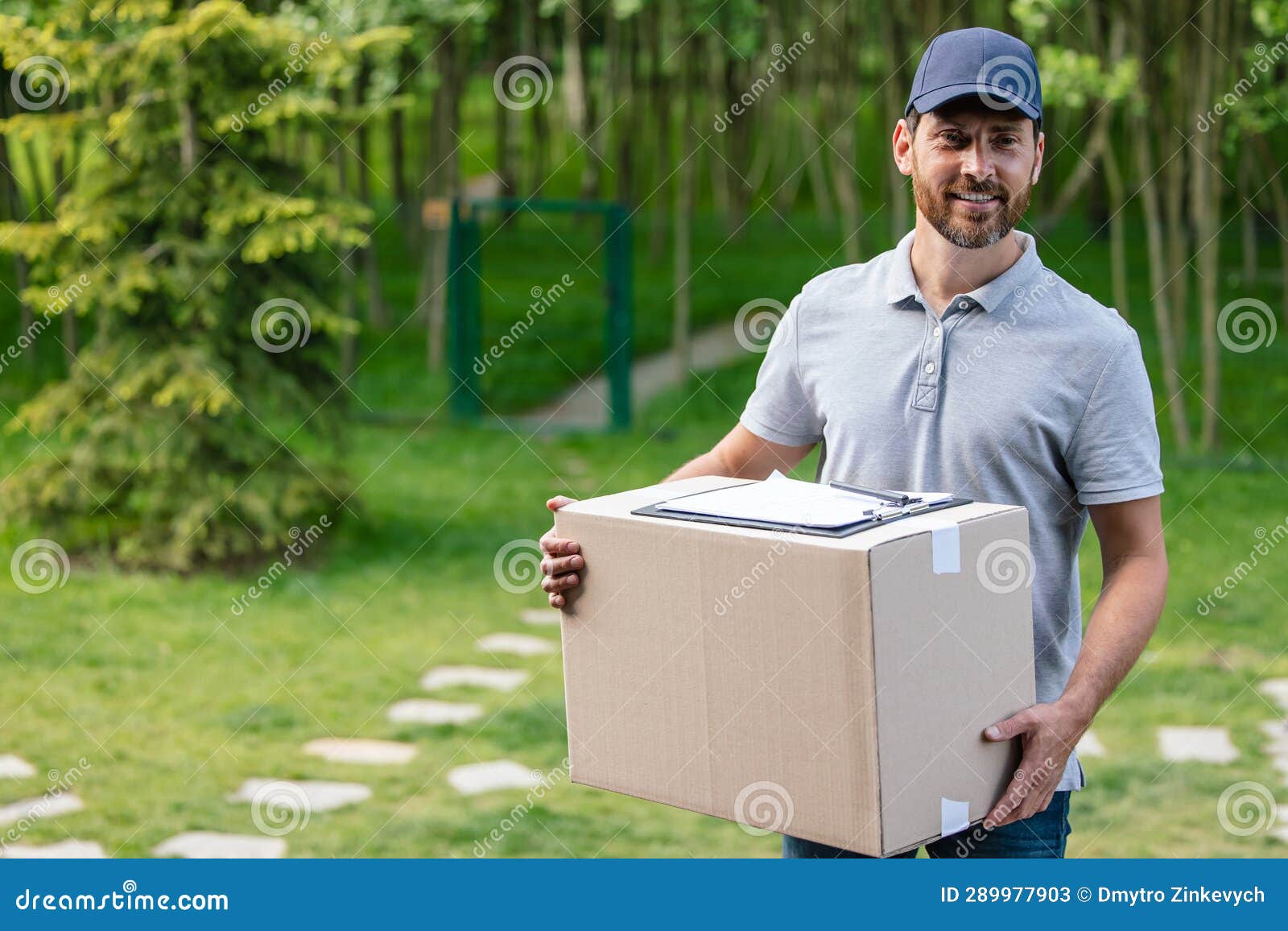 Postman Carrying Package and Documents Outdoors. Stock Image - Image of ...