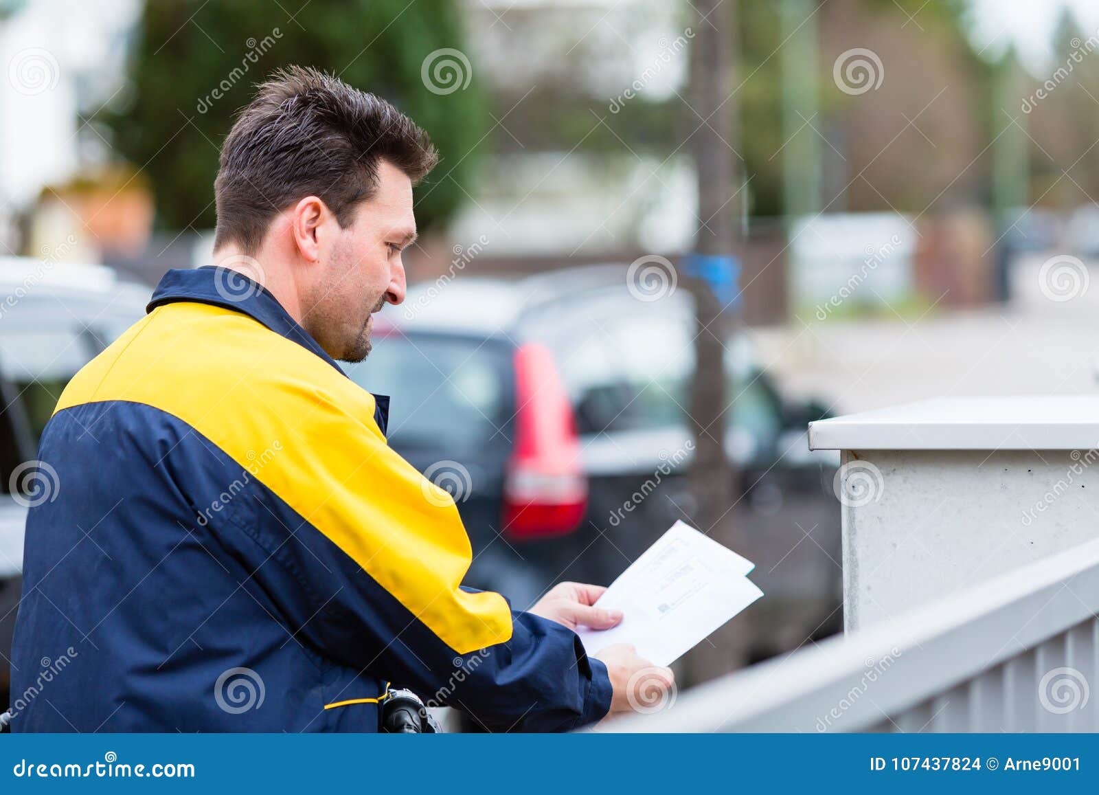 Postman Delivering Letters To Mailbox of Recipient Stock Photo - Image ...