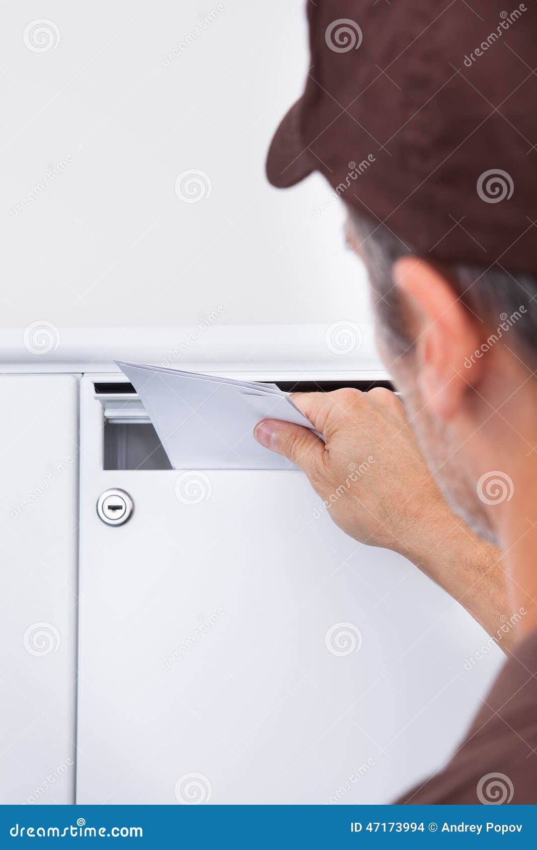 Postman Putting Letters in Mailbox Stock Photo - Image of post, brown ...