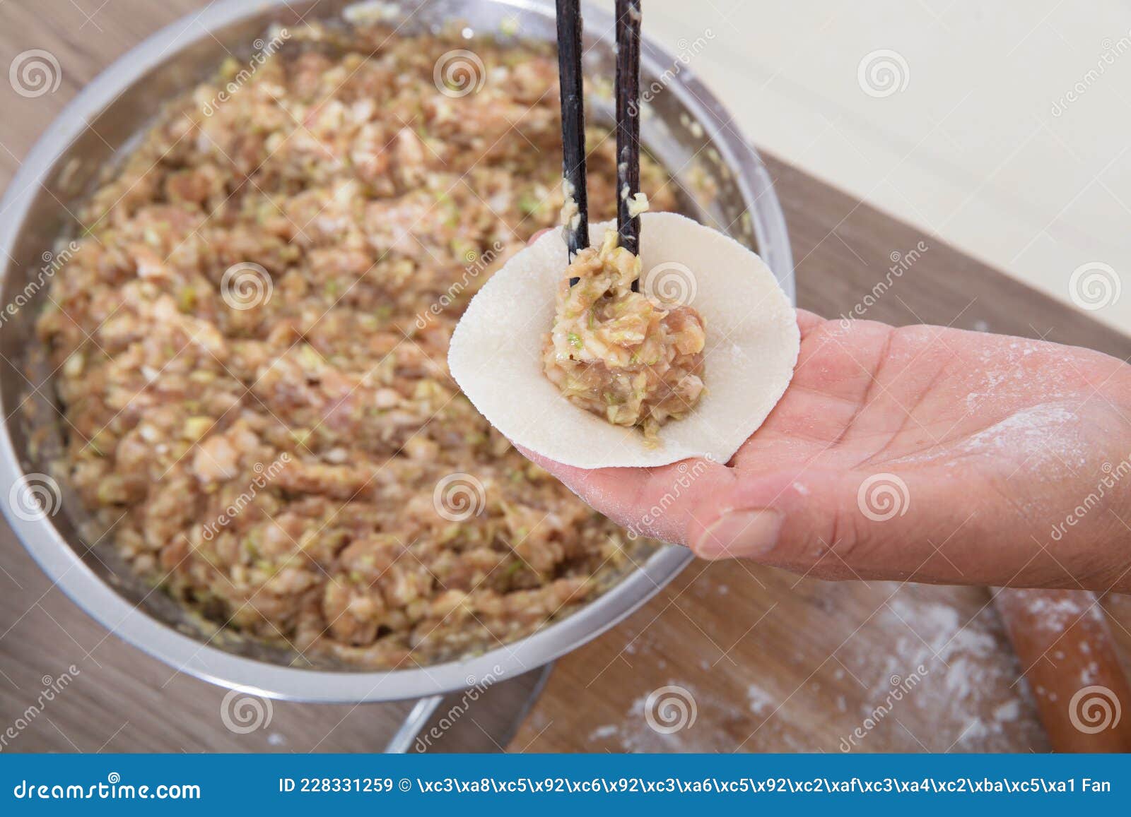 A Pot of Dumpling Stuffing and Two Hands are Making Dumplings Stock ...