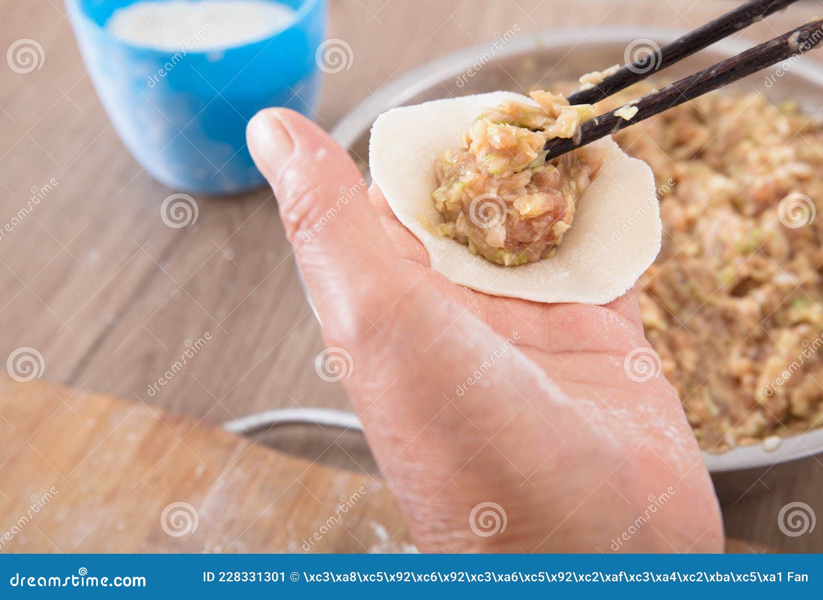 A Pot of Dumpling Stuffing and Two Hands are Making Dumplings Stock ...