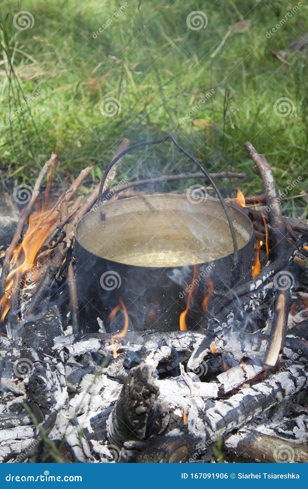 A Pot of Water is Heated on a Fire Made of Branches. Stock Photo ...