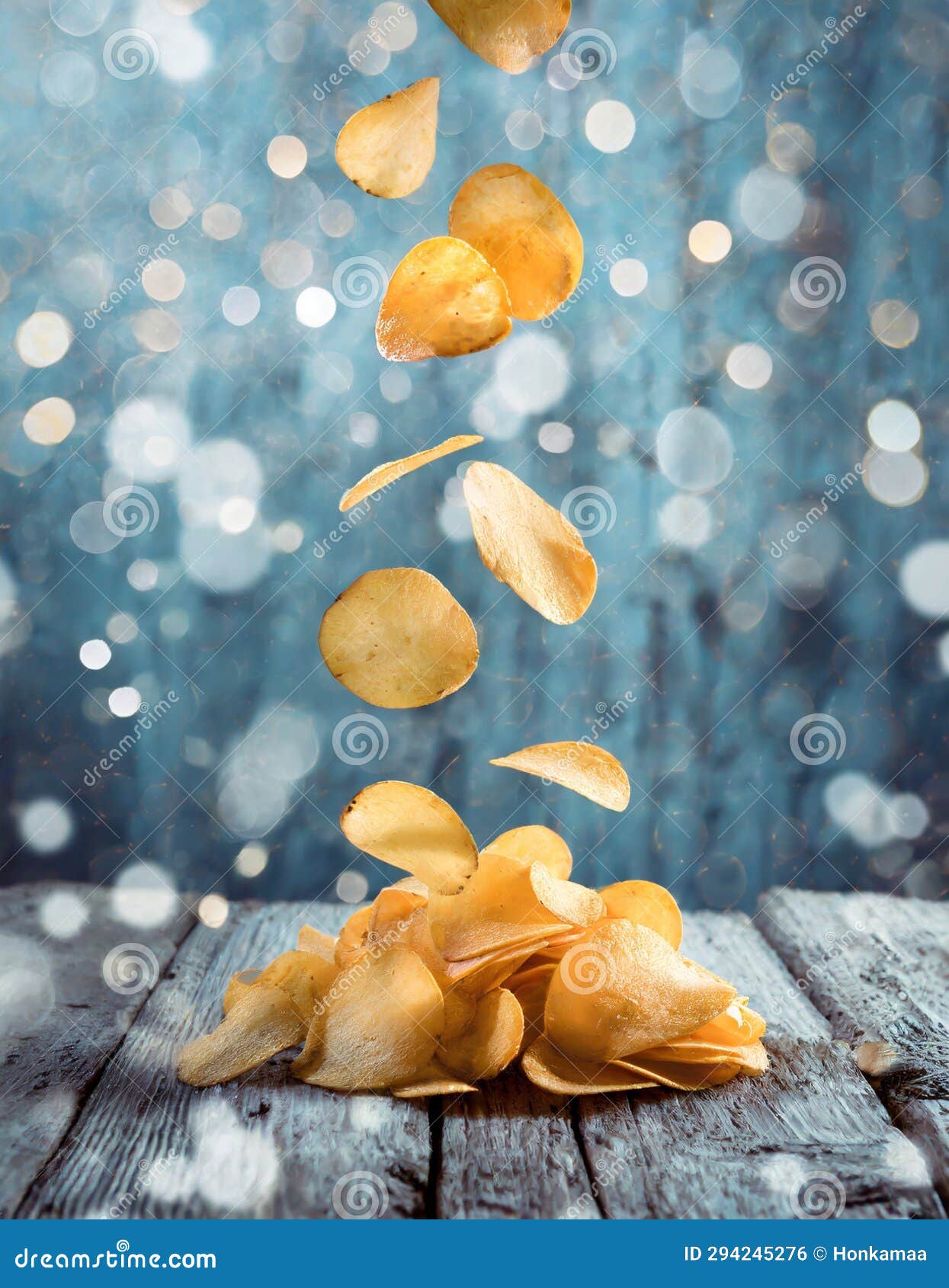 Potato Chips Falling Down on an Old Rustic Wooden Table Stock ...