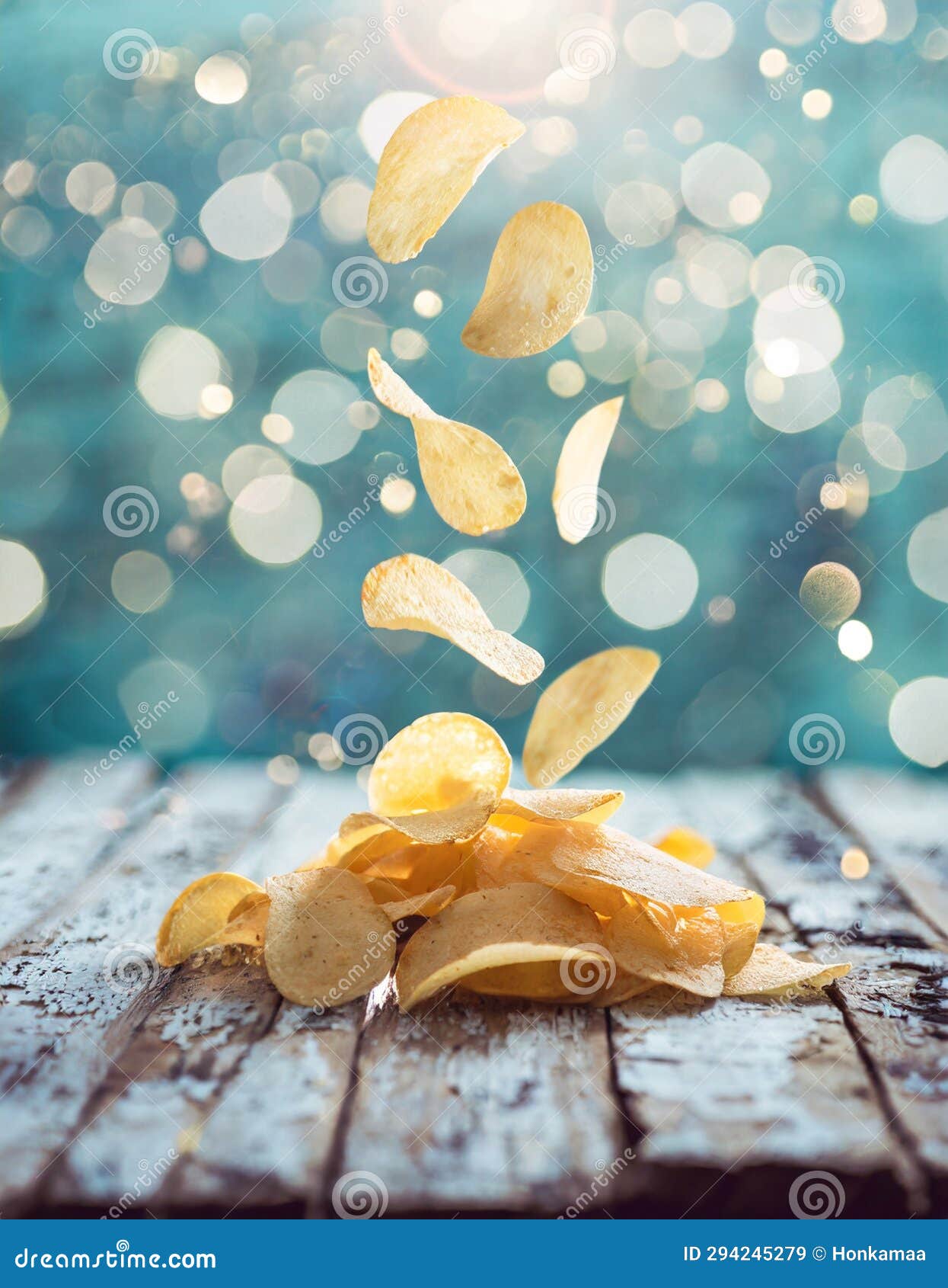 Potato Chips Falling Down on an Old Rustic Wooden Table Stock ...