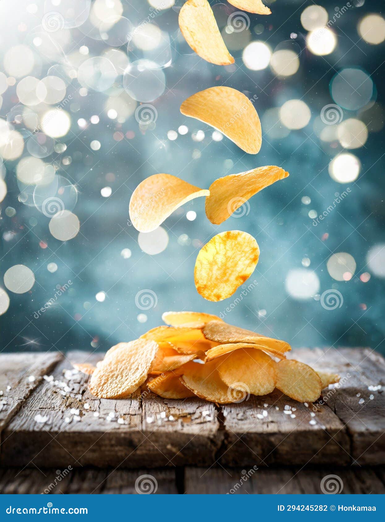 Potato Chips Falling Down on an Old Rustic Wooden Table Stock ...