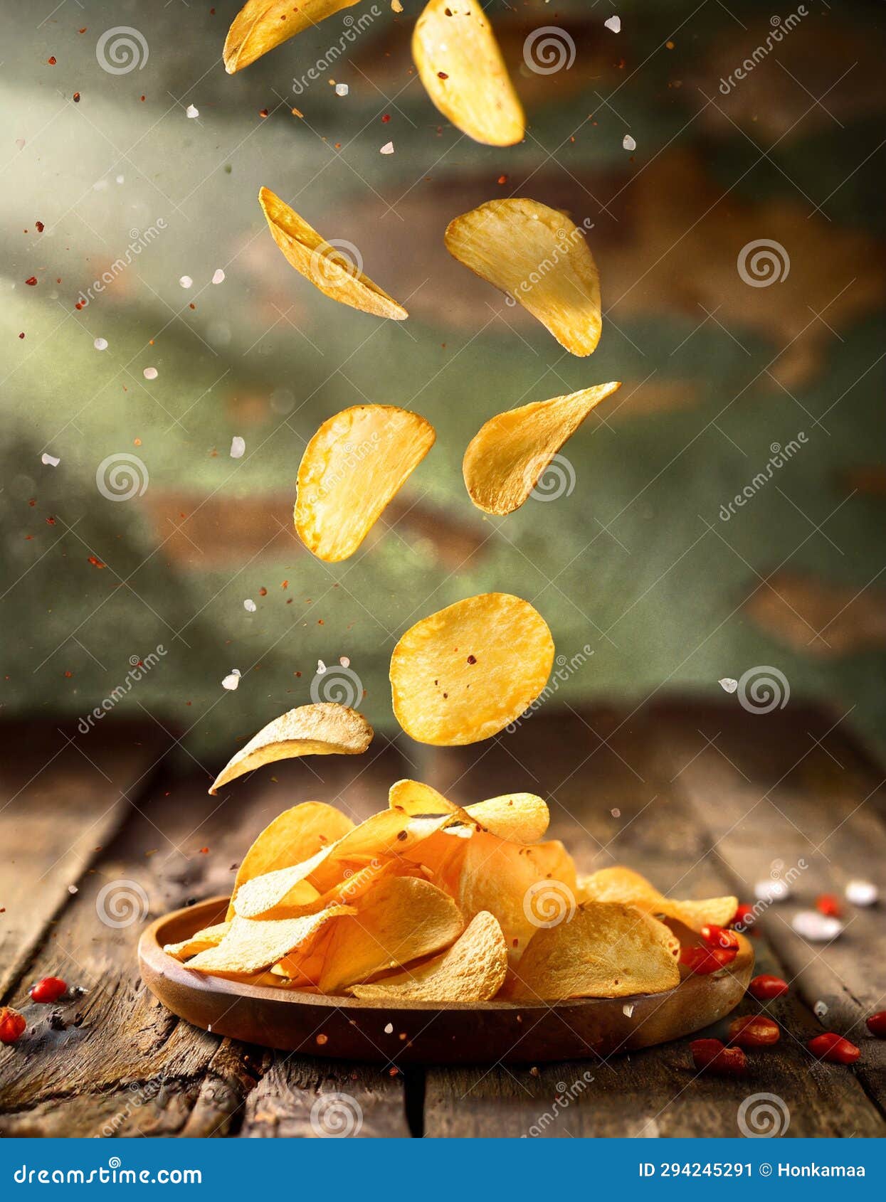 Potato Chips Falling Down on an Old Rustic Wooden Table Stock ...