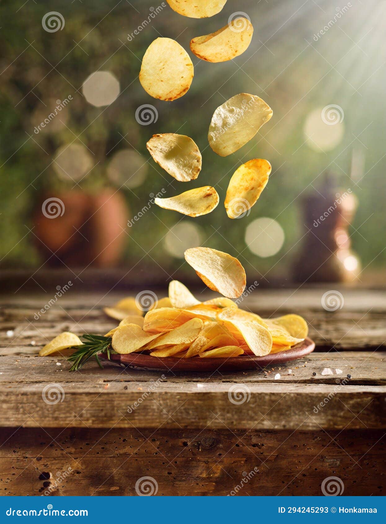 Potato Chips Falling Down on an Old Rustic Wooden Table Stock ...
