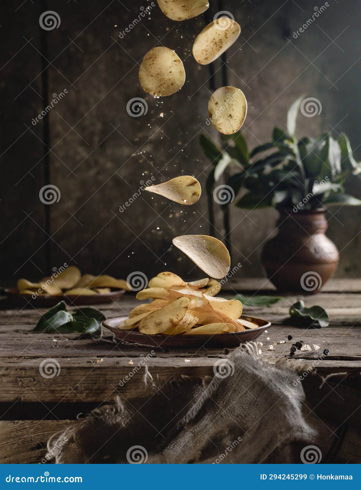 Potato Chips Falling Down on an Old Rustic Wooden Table Stock ...