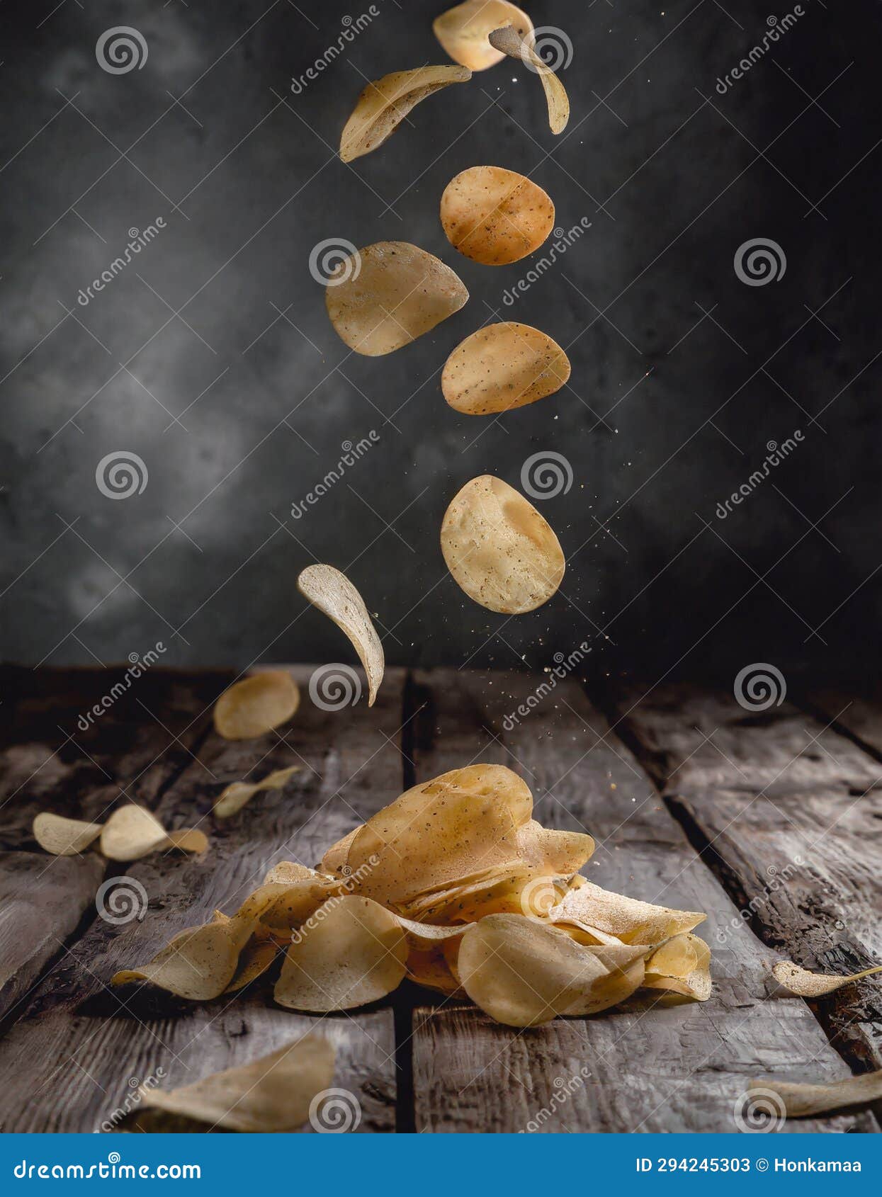 Potato Chips Falling Down on an Old Rustic Wooden Table Stock ...