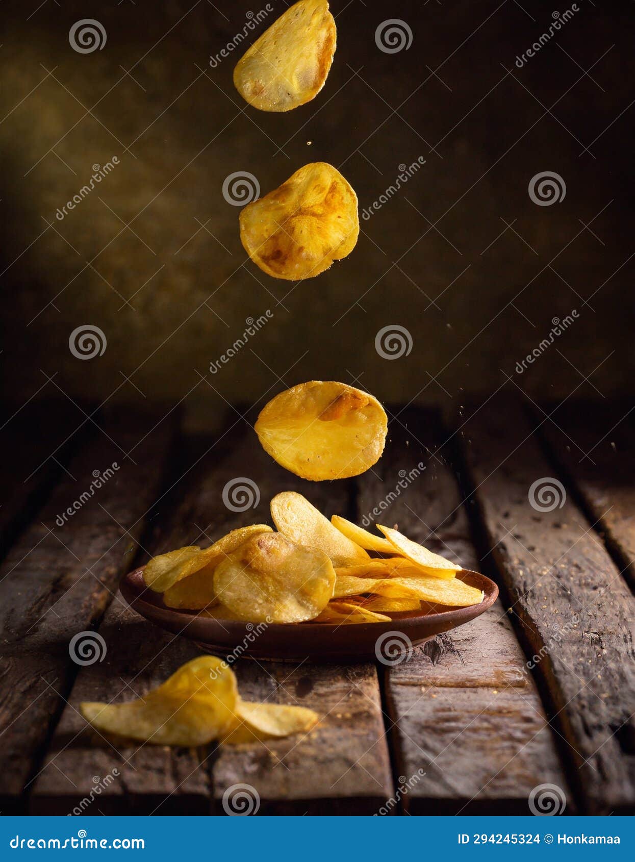 Potato Chips Falling Down on an Old Rustic Wooden Table Stock ...
