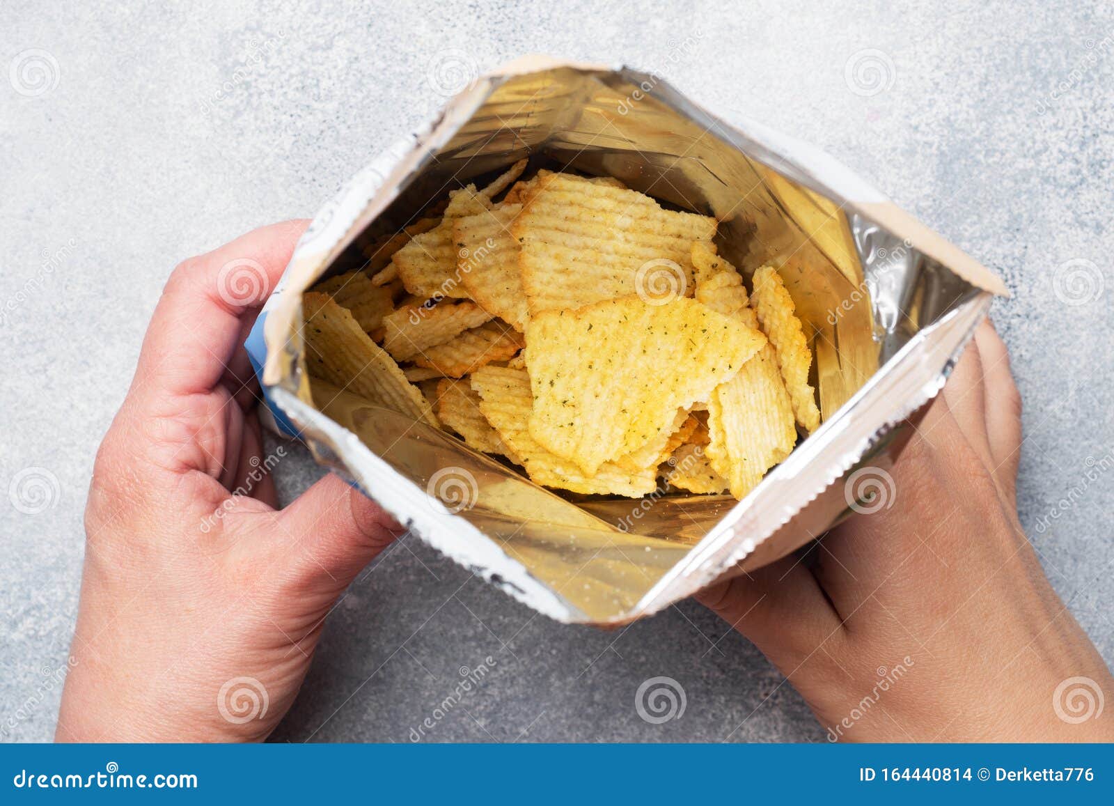 Potato Chips with Spicy in an Open Package Hold Hands. Close Up ...