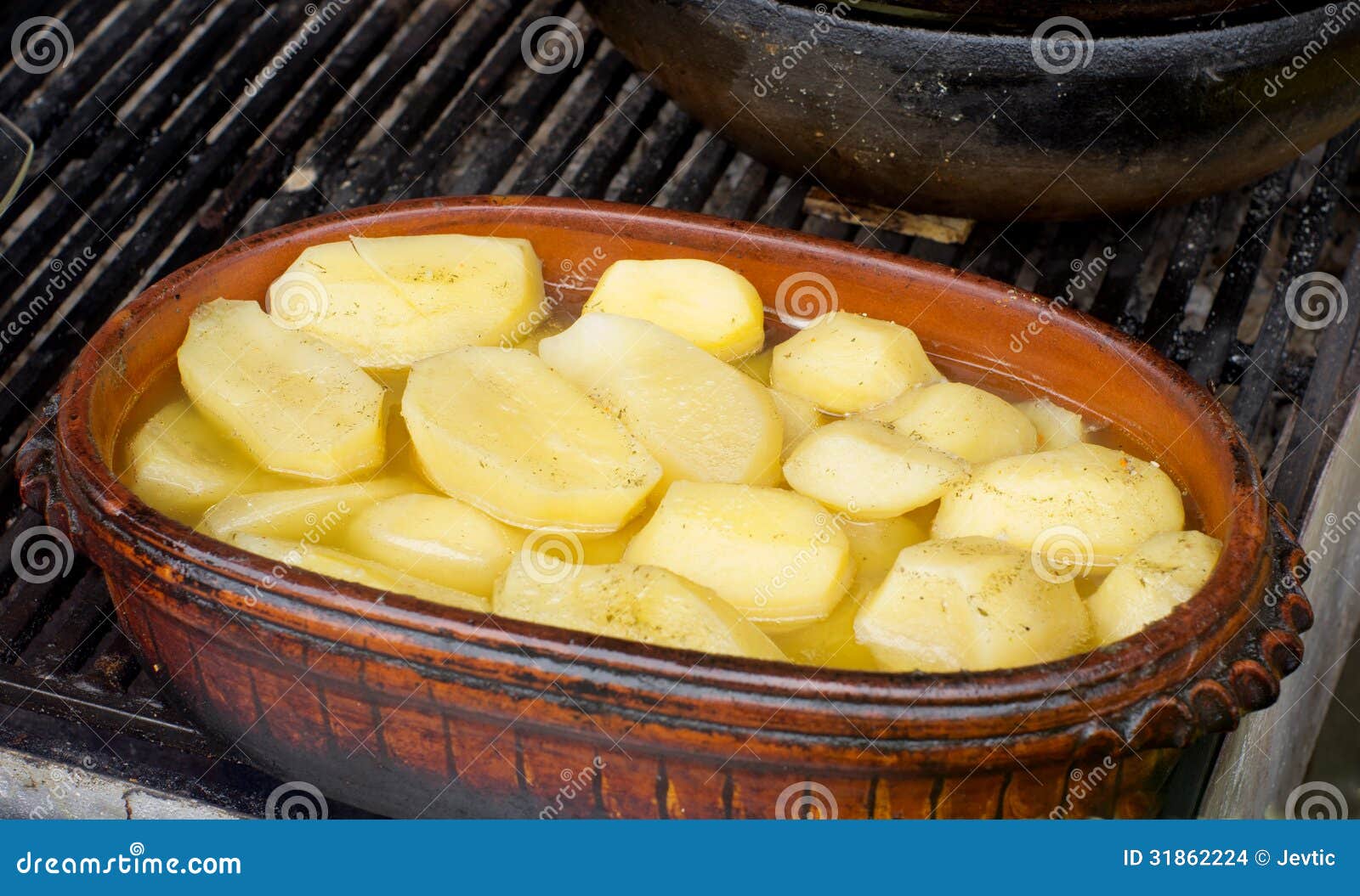 Potato in clay vessel stock photo. Image of embers, clay - 31862224