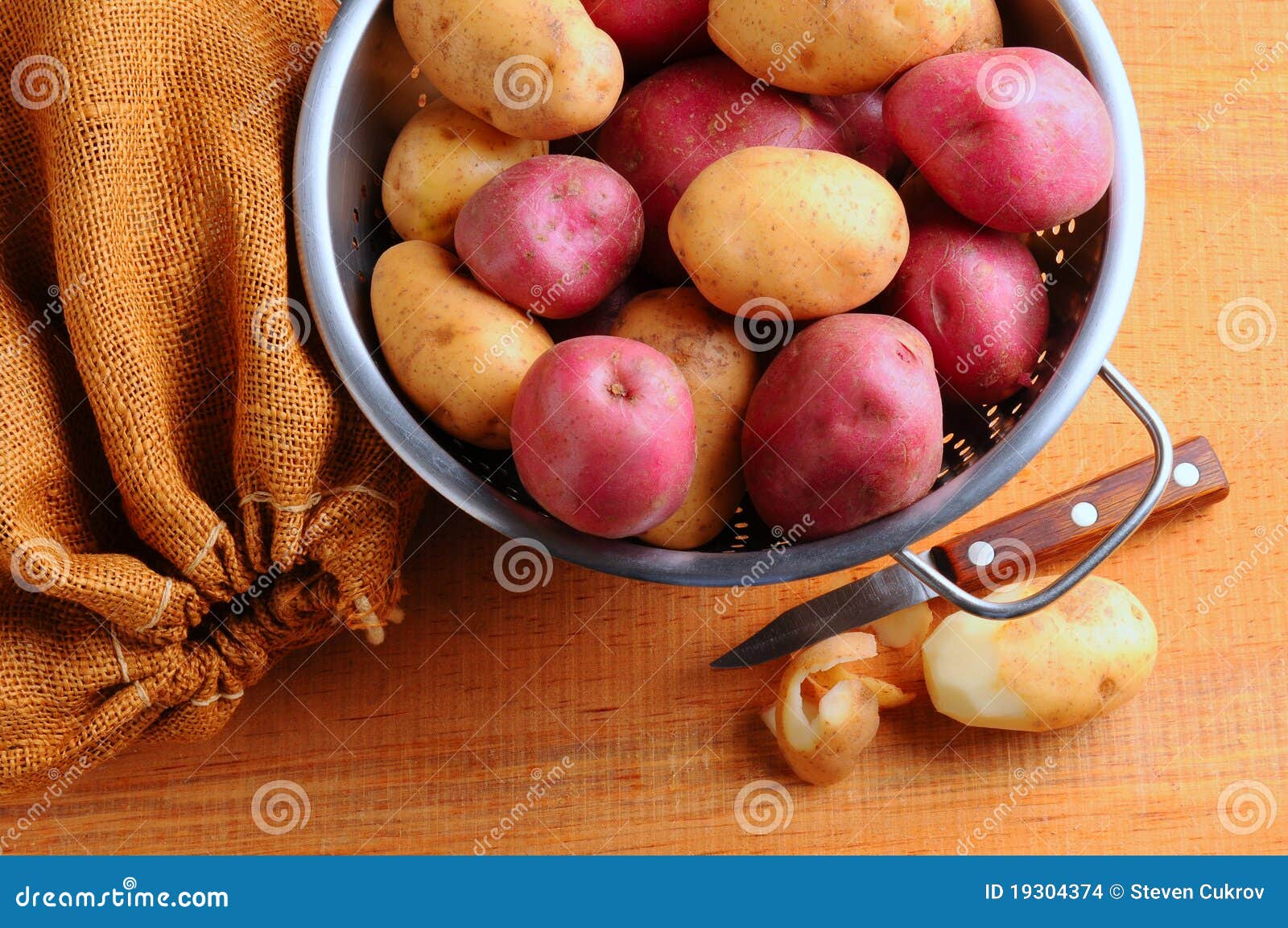 Potatoes in Colander with Burlap Sack Stock Photo - Image of peeled ...