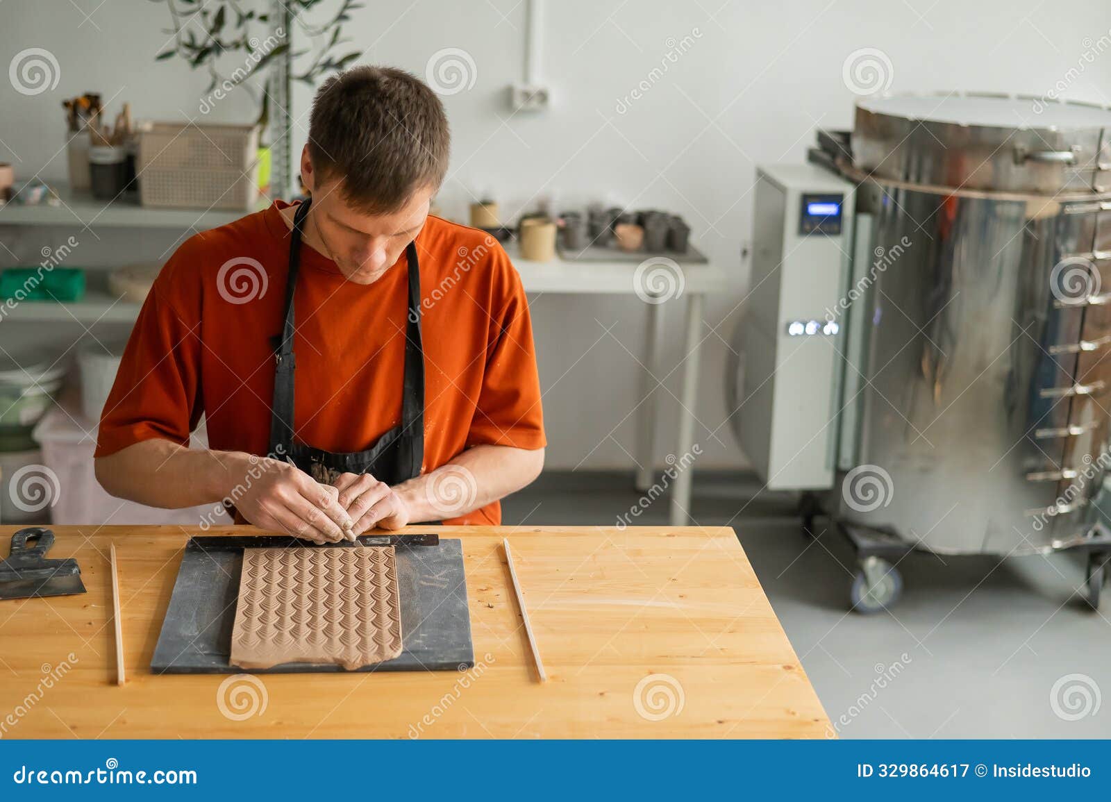 A Potter Cuts a Piece of Rolled Clay with Patterns. Stock Image - Image ...