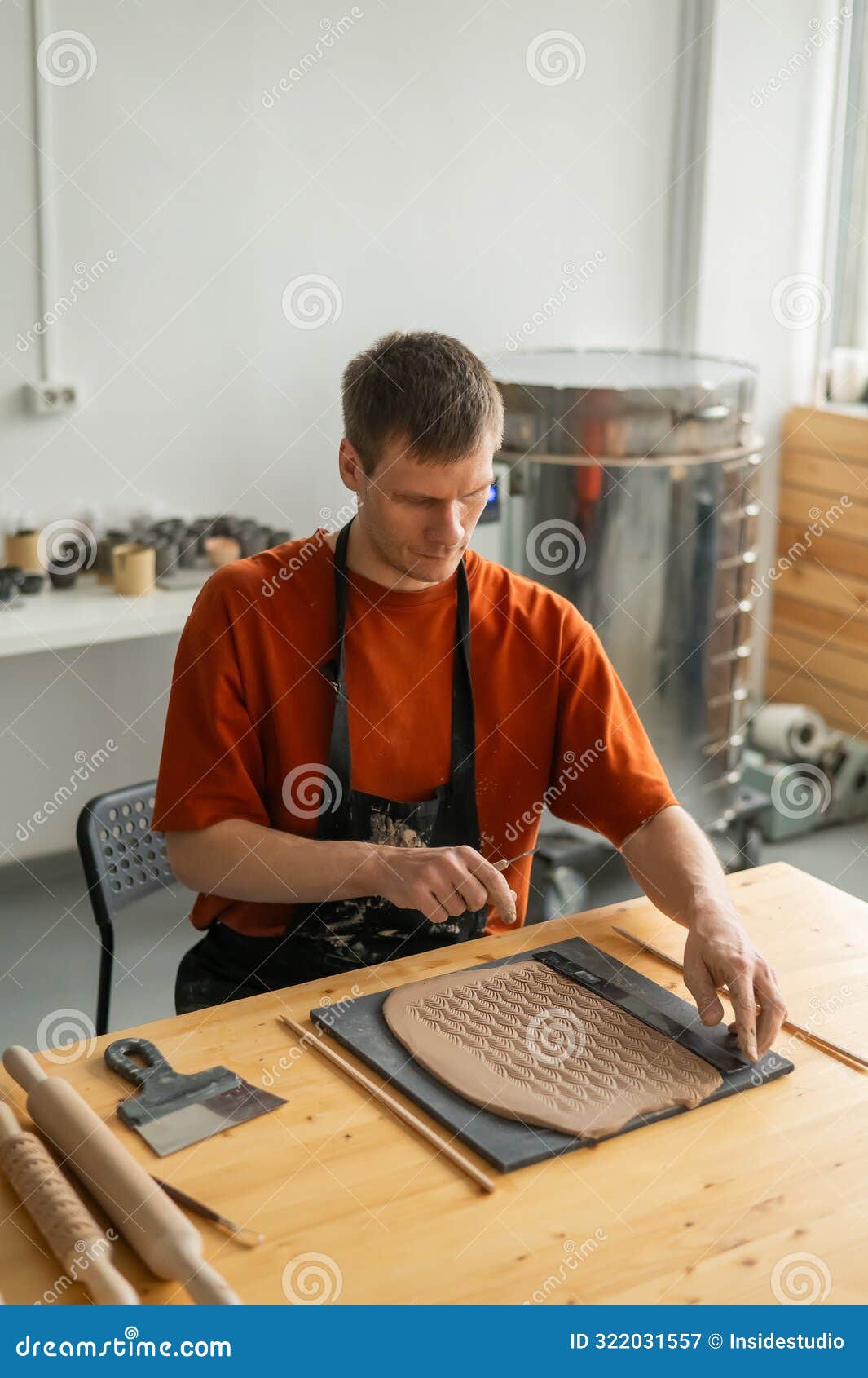 A Potter Cuts a Piece of Rolled Clay with Patterns. Vertical Photo ...