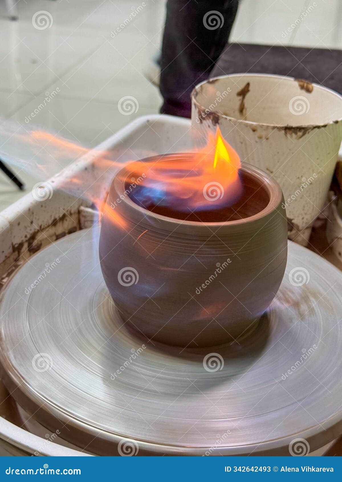 A Pottery Wheel with a Clay Vase in the Firing Process. Flames Create a ...