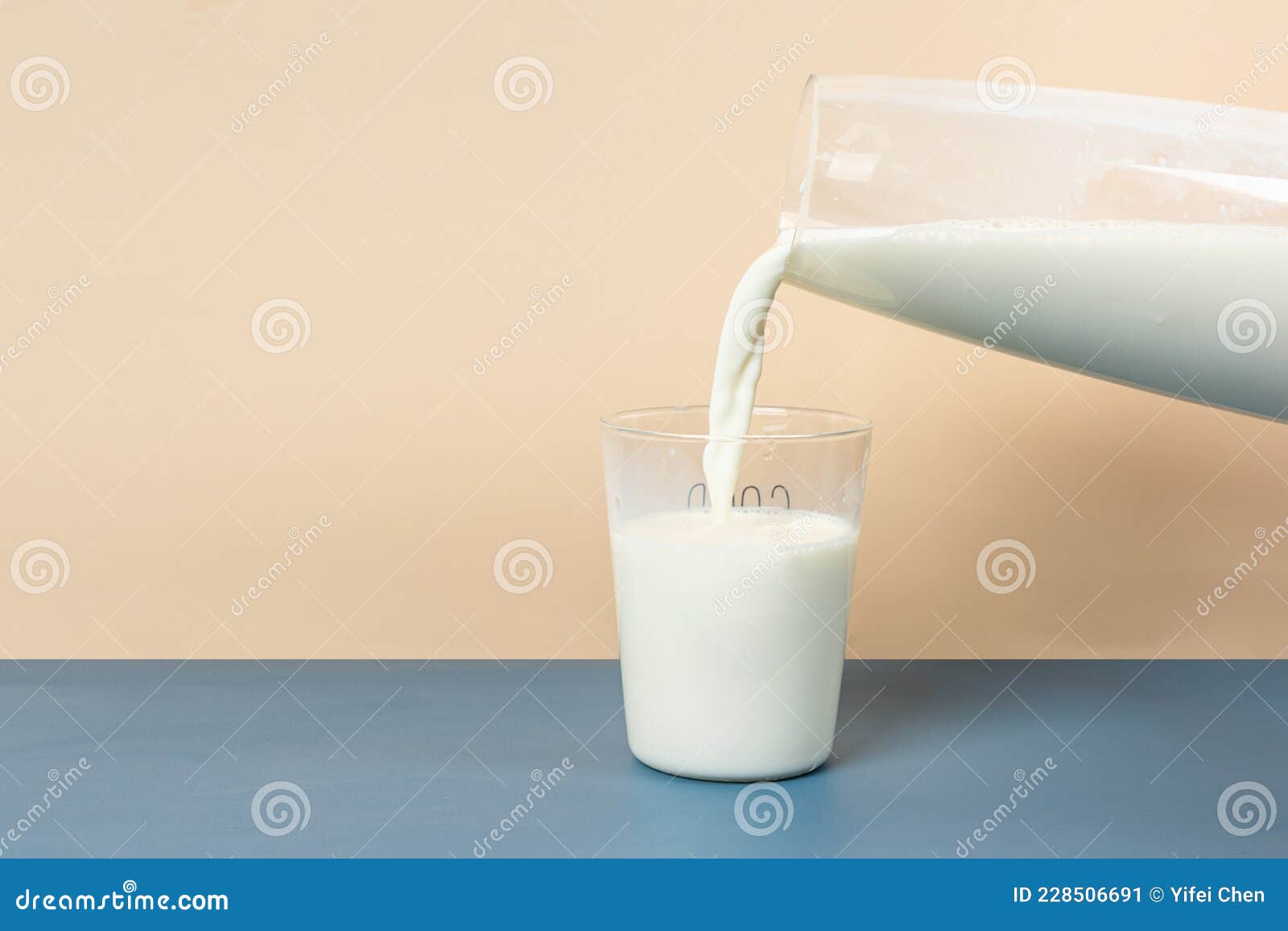 Pour Milk into a Glass from a Large Glass Milk Bottle Stock Image ...