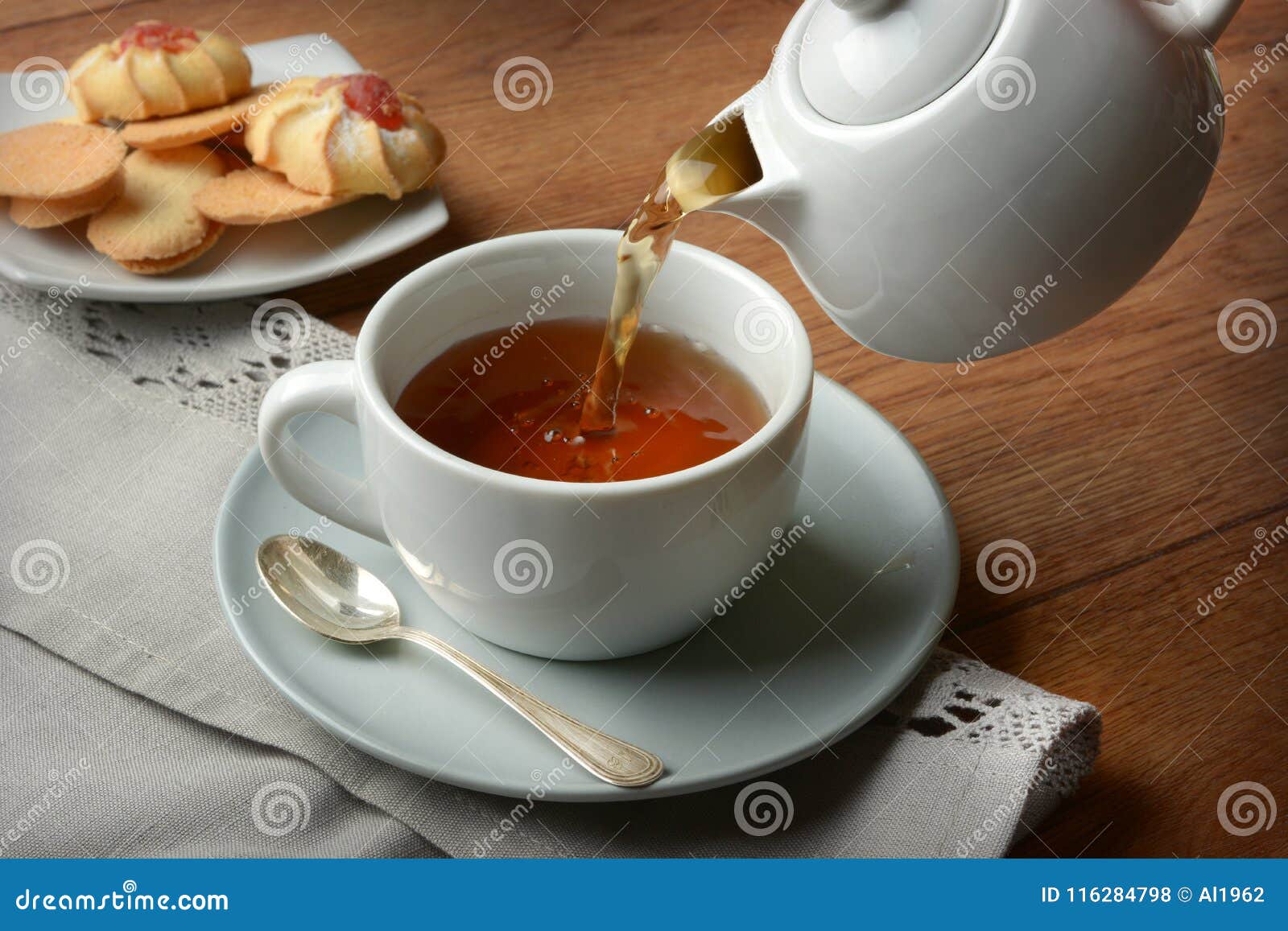 Pour the tea into the cup stock photo. Image of wooden - 116284798
