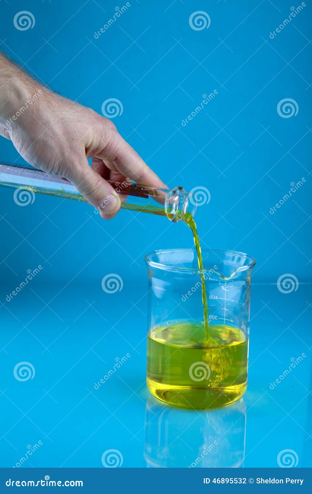 Pouring into a beaker stock photo. Image of graduated - 46895532