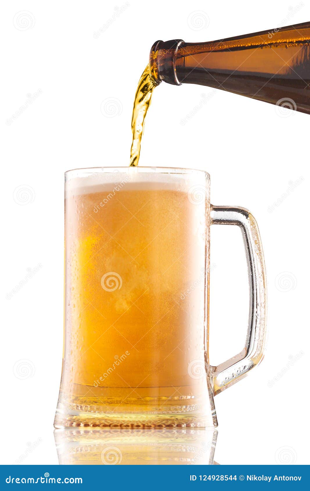 Pouring Beer From Bottle Into A Mug With Foam Isolated On White