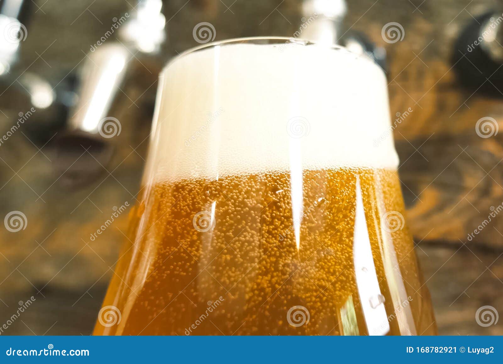 Pouring Beer Into A Glass From The Tap At Bar Beer Bottling Stock