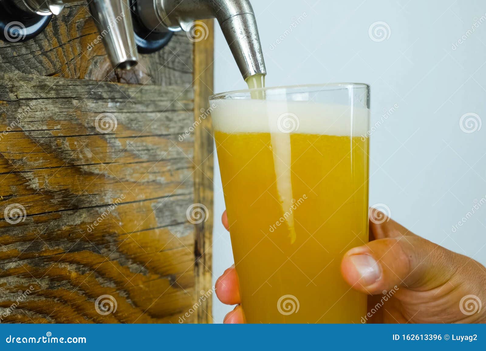 Pouring Beer Into A Glass From The Tap At Bar Beer Bottling Stock