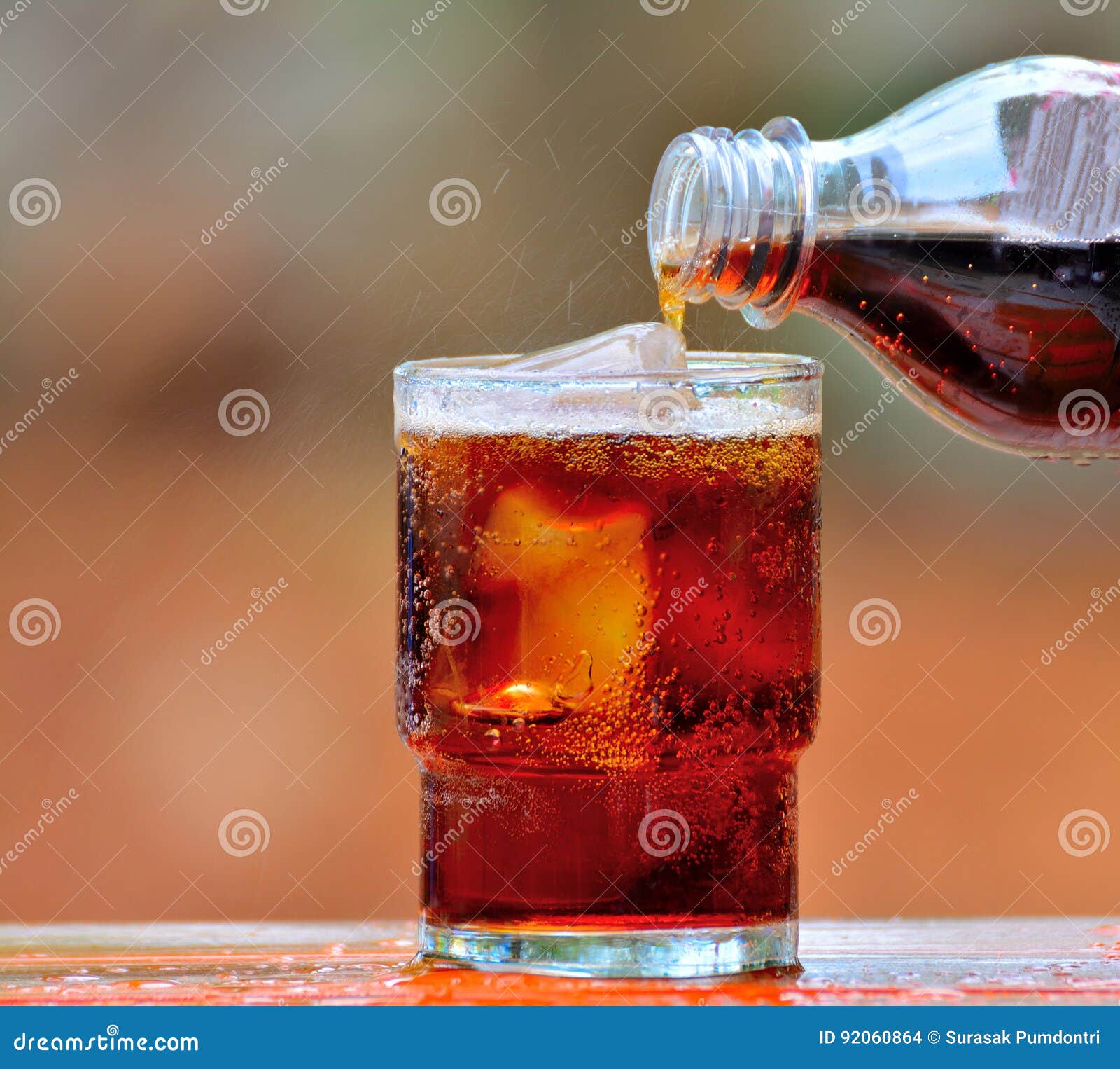Pouring Cola into a Glass of Ice. Stock Photo - Image of glass, drop ...