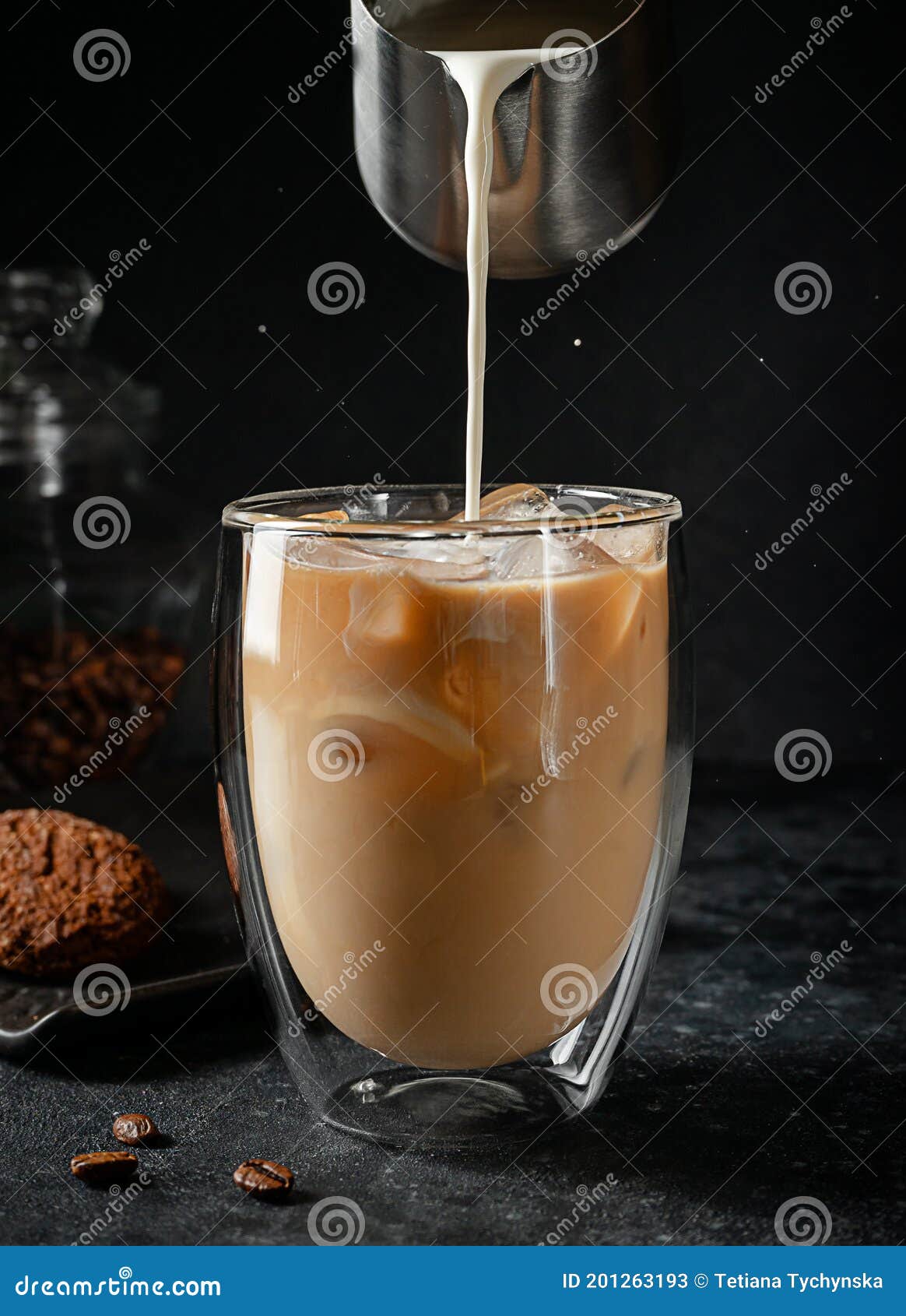 Pouring Cream into the Glass of Iced Coffee on Black Background. Stock ...