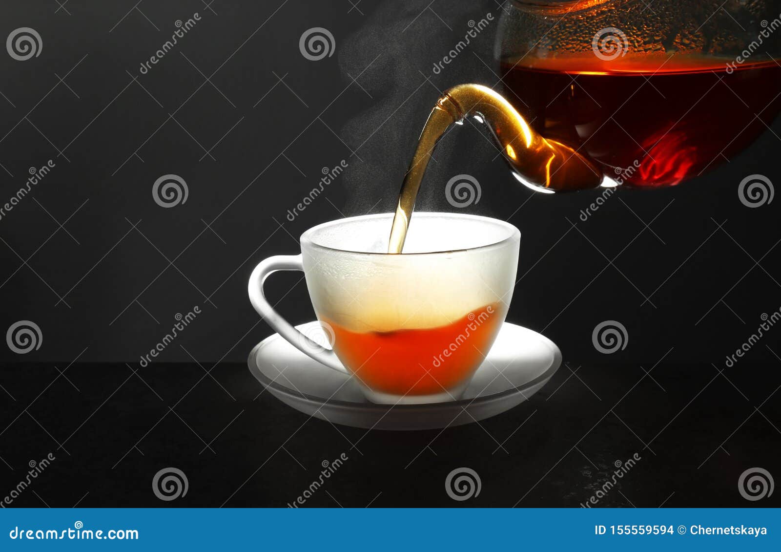 Pouring Fresh Hot Tea into Cup on Table Against Grey Background Stock ...