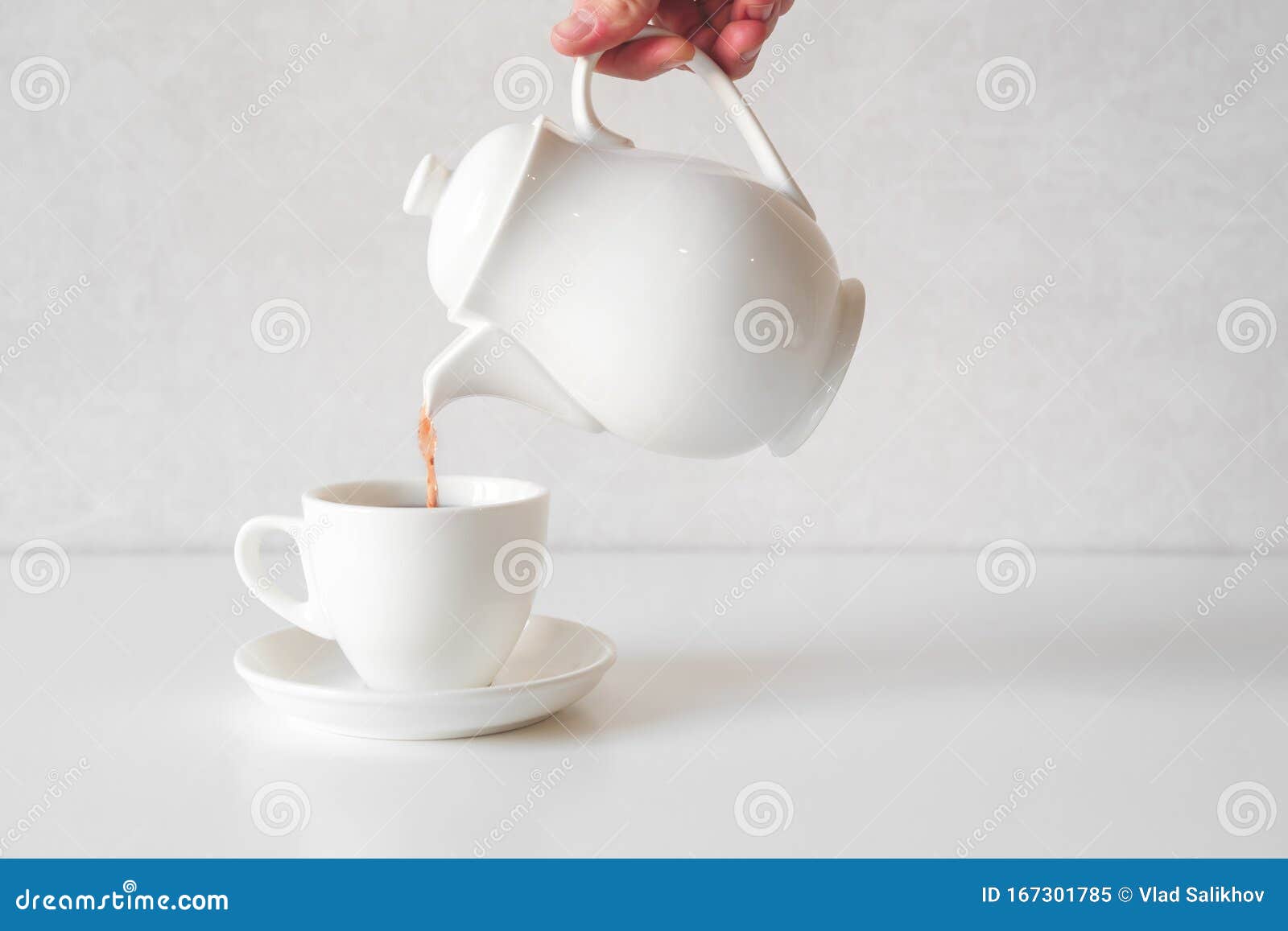 Pouring Fresh Tea from White Teapot into White Cup Stock Image - Image ...