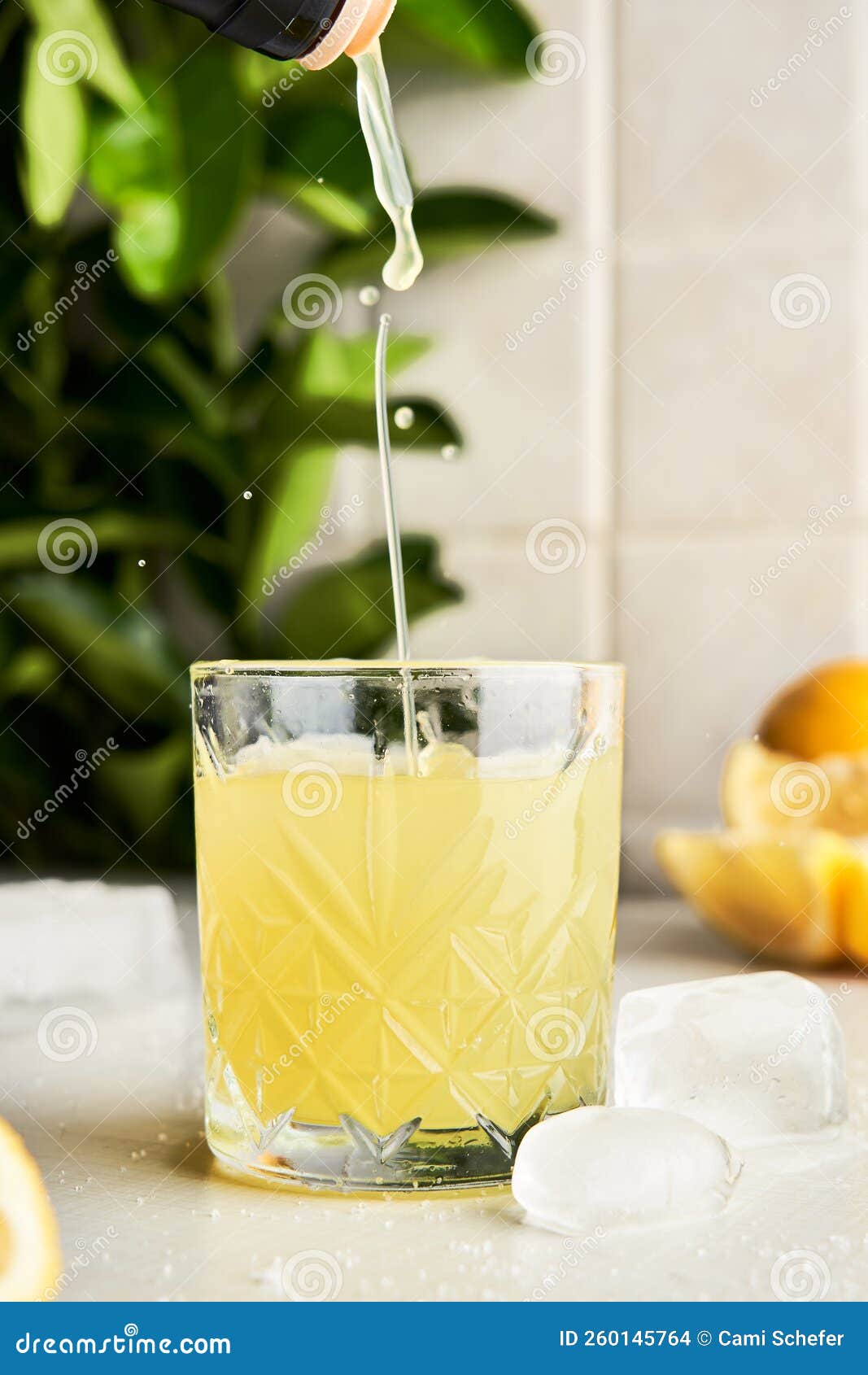 Pouring Italian Typical Digestive Limoncello in a Glass with Kitchen ...