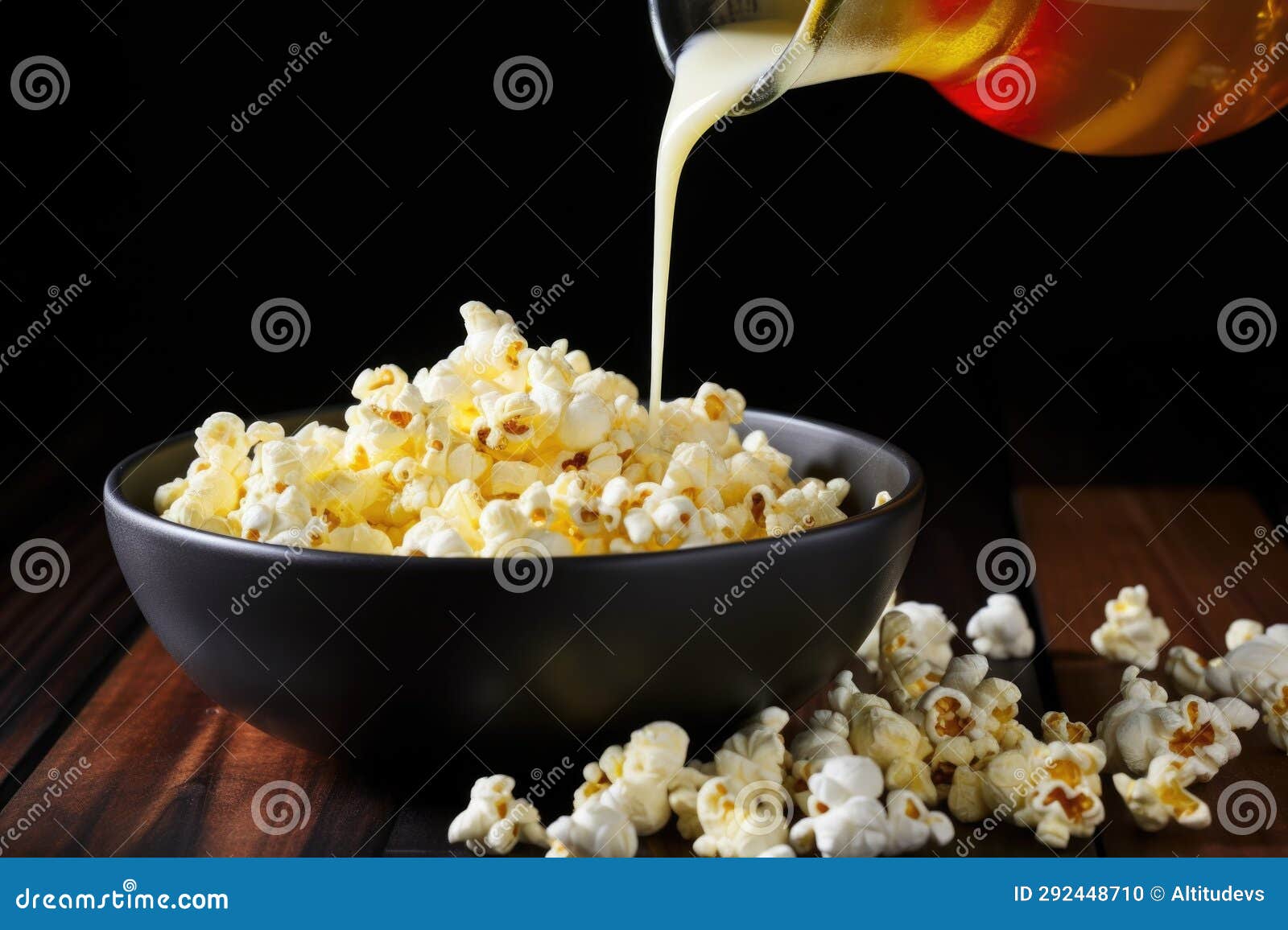 Pouring Melted Butter Onto a Bowl of Popcorn Stock Photo - Image of ...