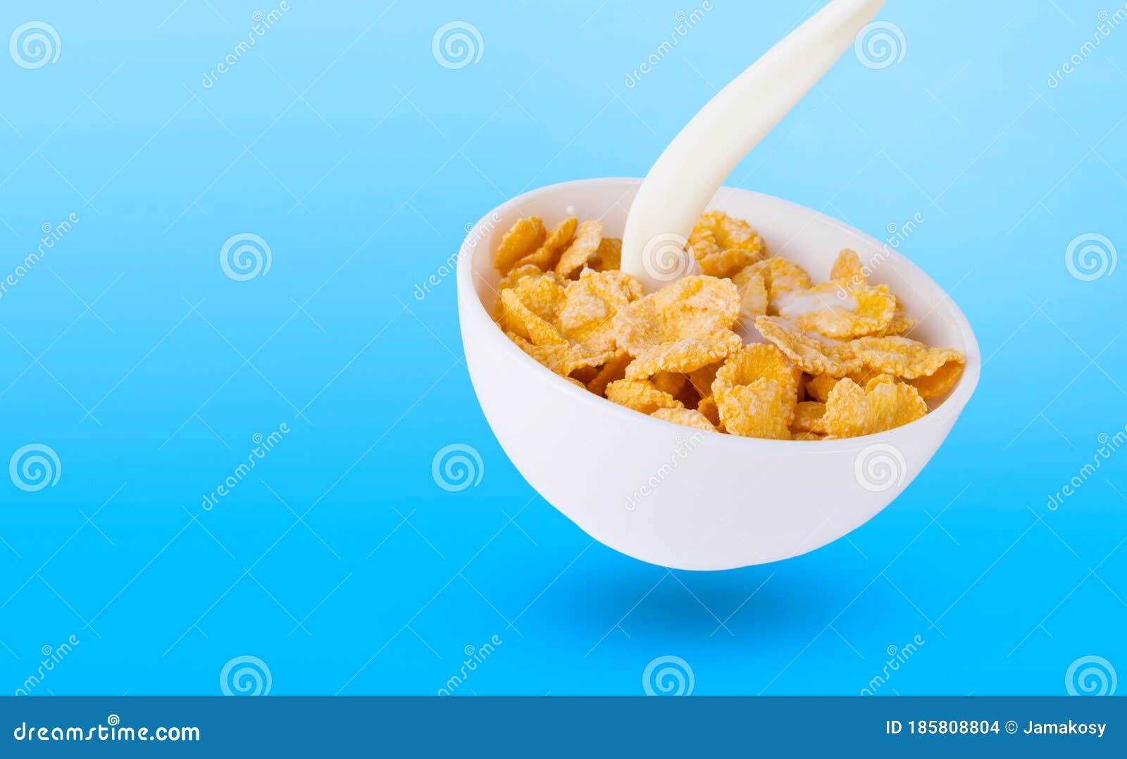 Pouring Milk into Corn Flakes Creating Splash Isolated on White ...