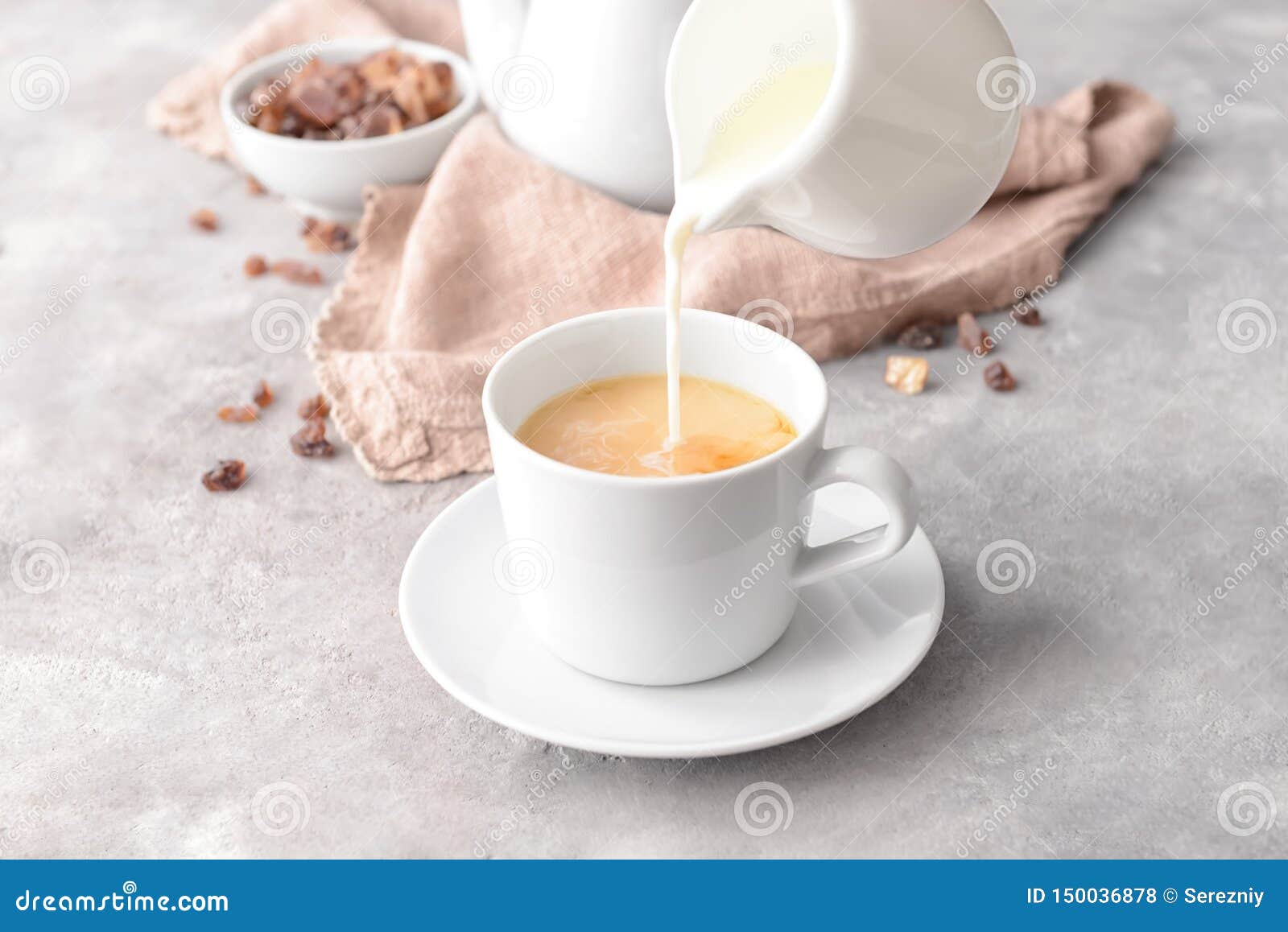 Pouring of Milk into Cup of Tea on Table Stock Photo - Image of pouring ...