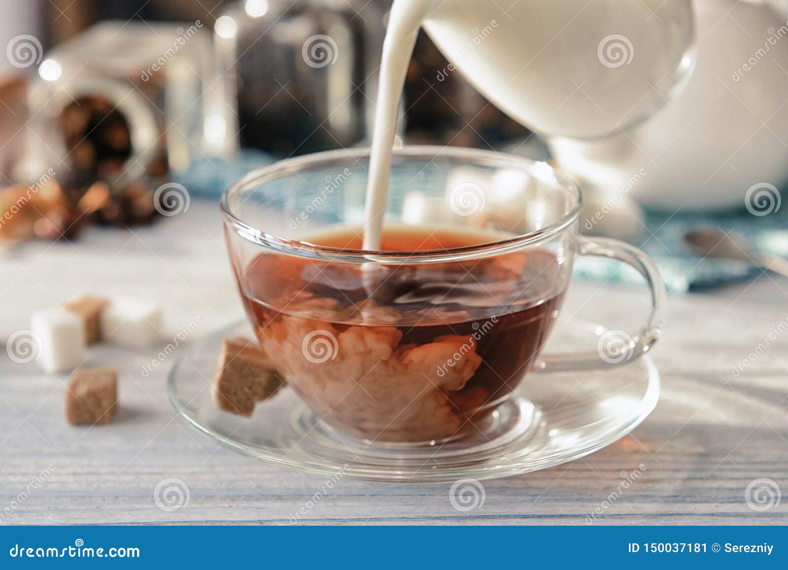Pouring of Milk into Cup of Tea on Wooden Table Stock Image - Image of ...