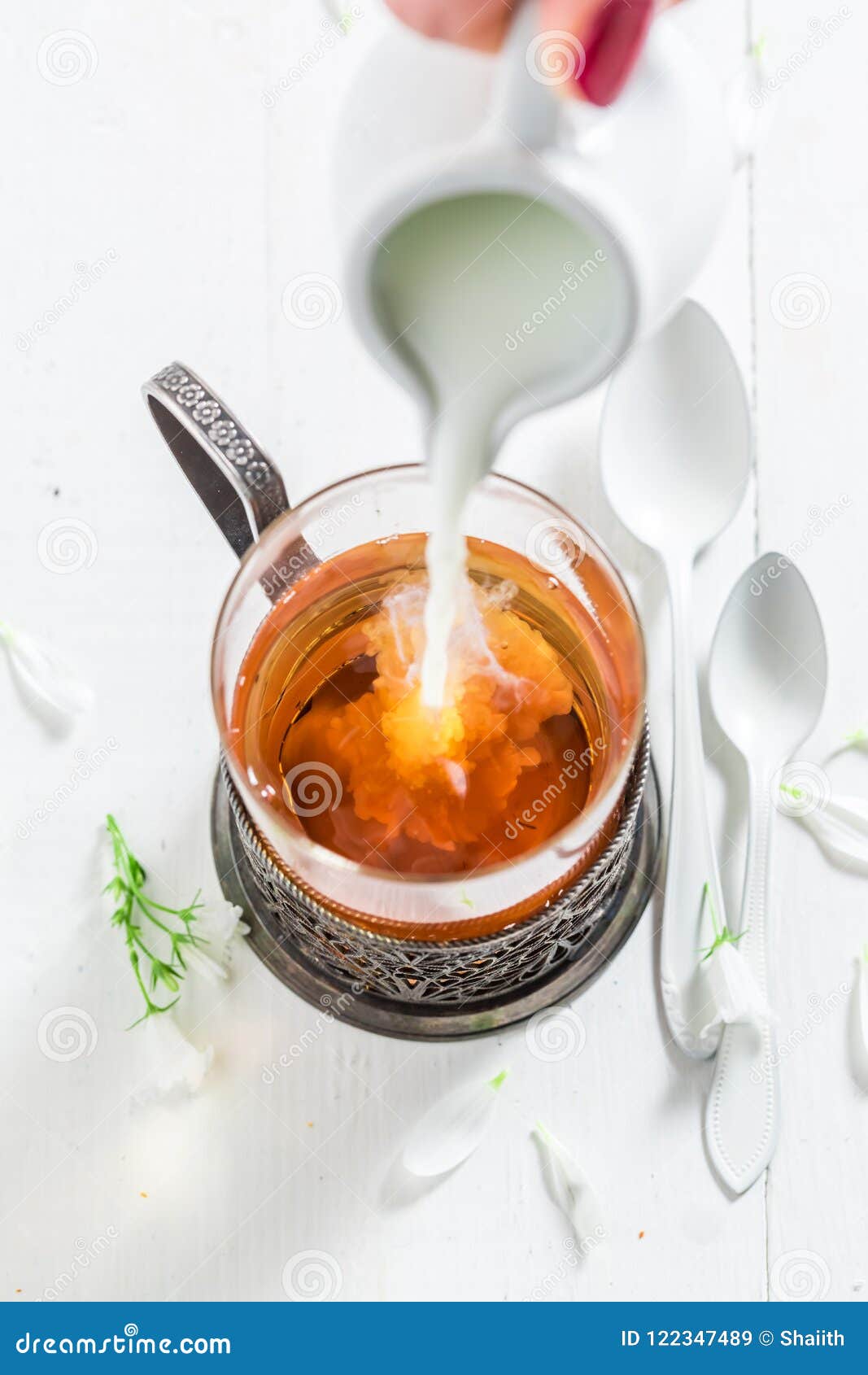 Pouring Milk into Glass of Tea on White Background Stock Image - Image ...