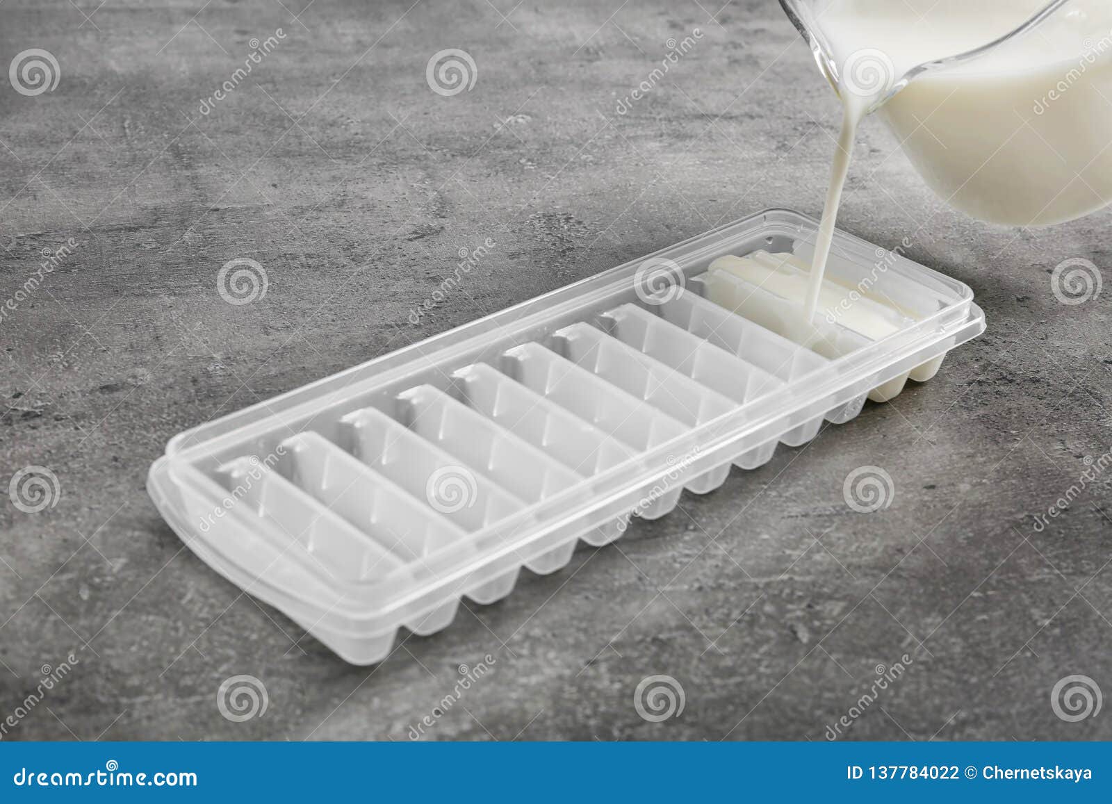 Pouring Milk into Ice Cube Tray on Table Stock Photo - Image of food ...