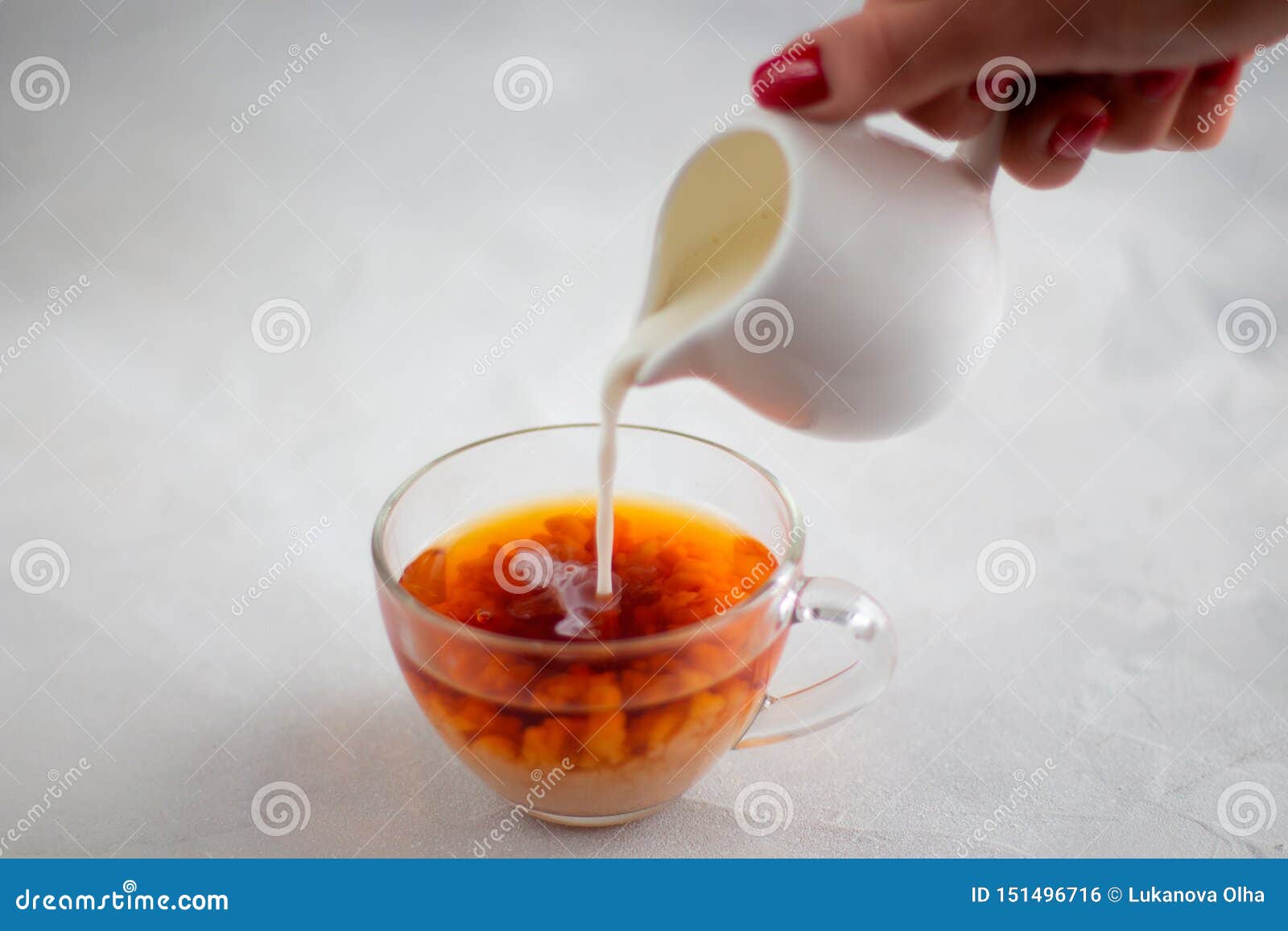 Pouring Milk from the Jug into a Cup of Black Tea Stock Photo - Image ...